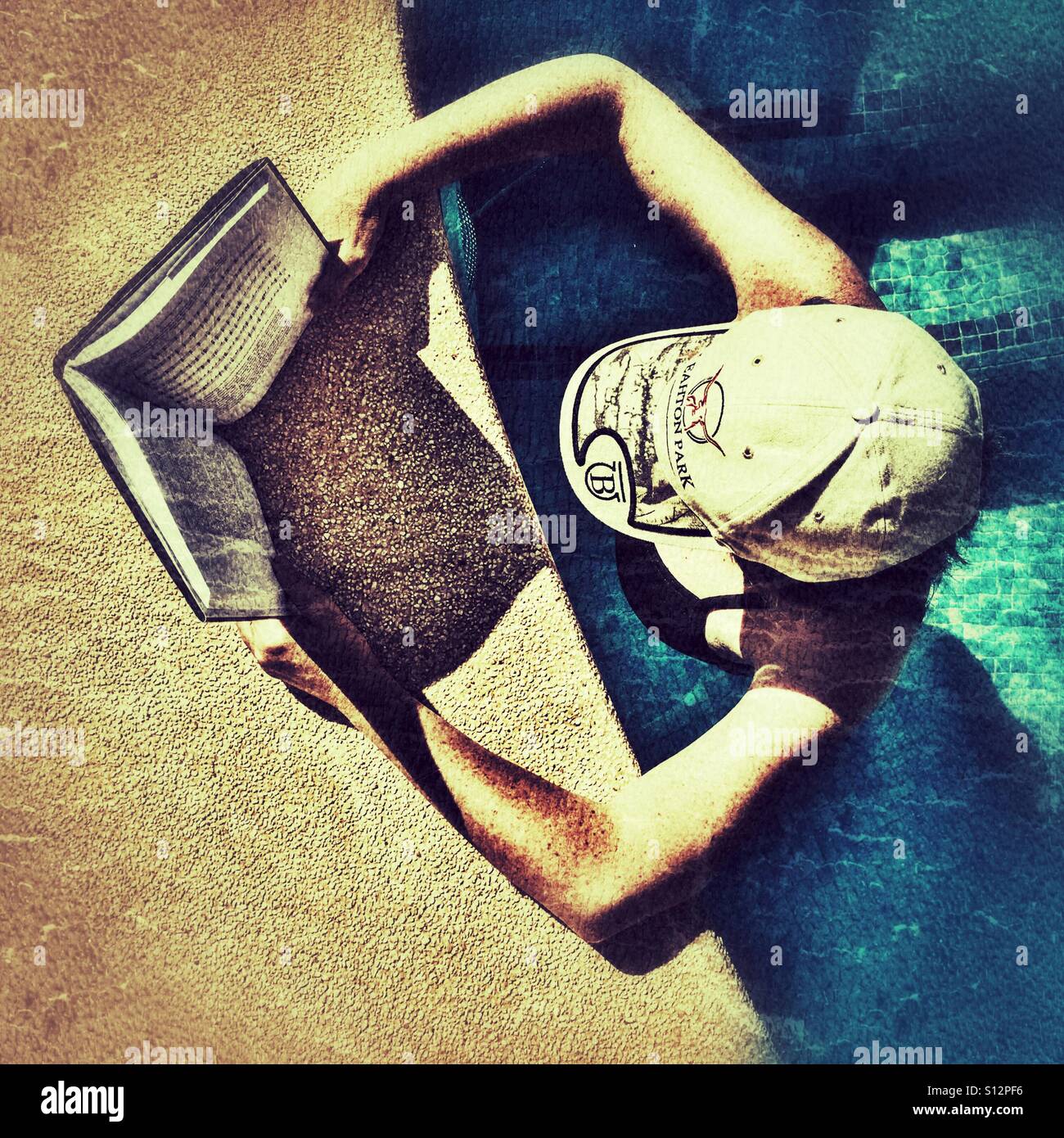 Woman standing in swimming pool, reading a book Stock Photo - Alamy