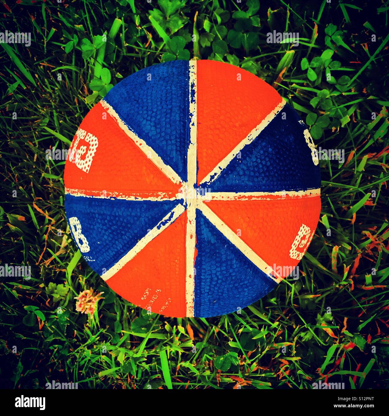 Small basketball ball on grass Stock Photo - Alamy