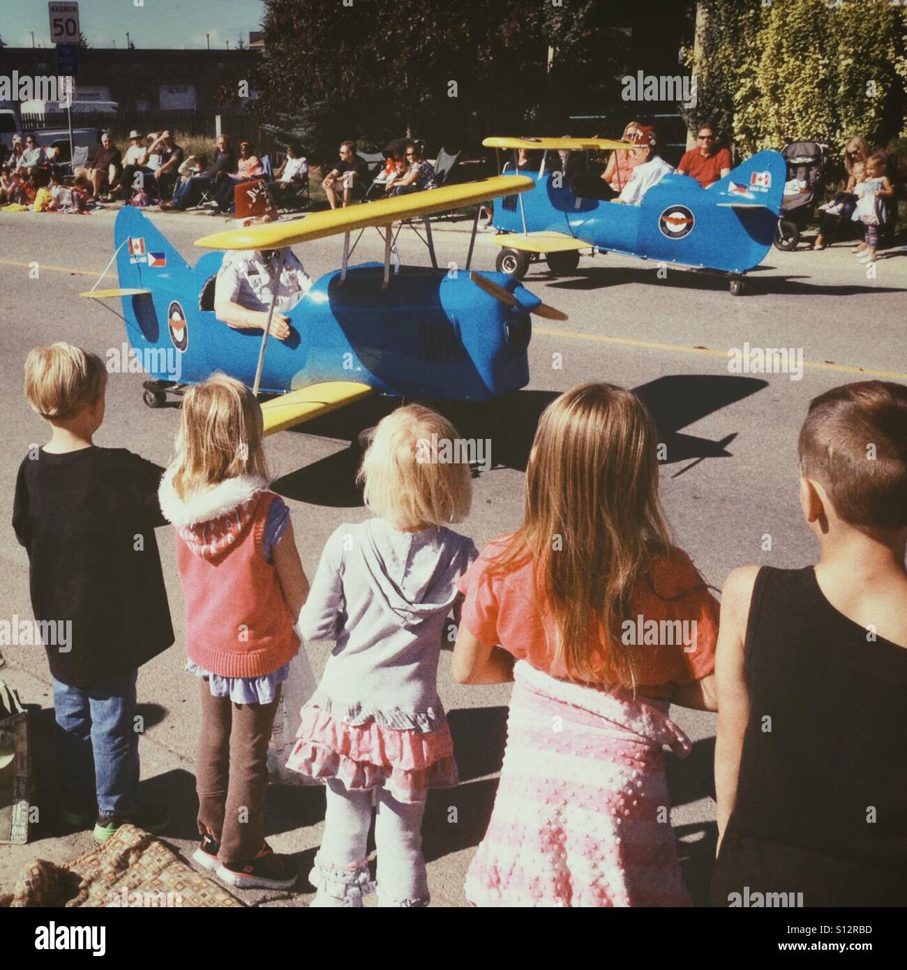 Children enjoy watching participants in a parade Stock Photo - Alamy