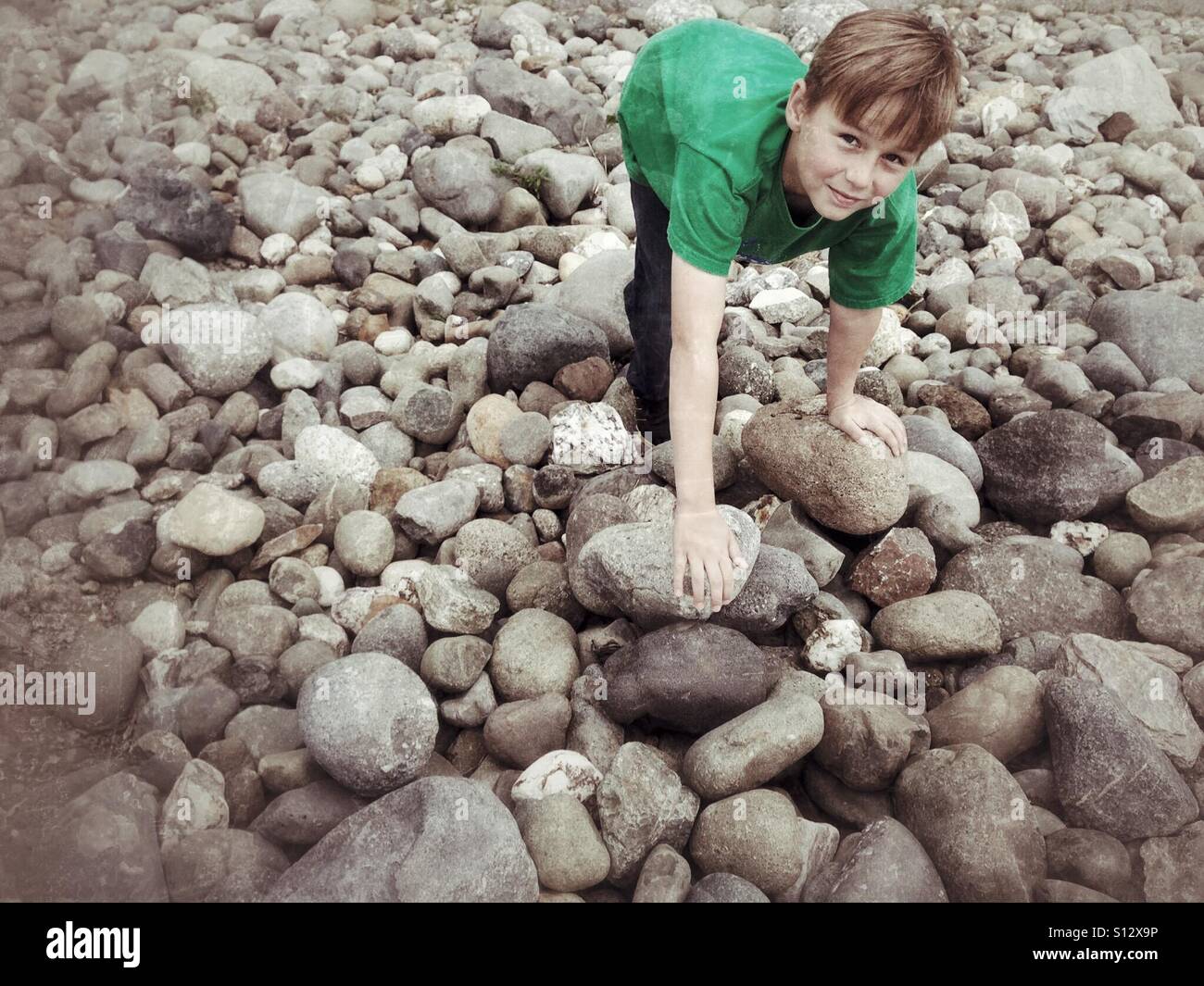 Boy climbing rocks hi-res stock photography and images - Alamy