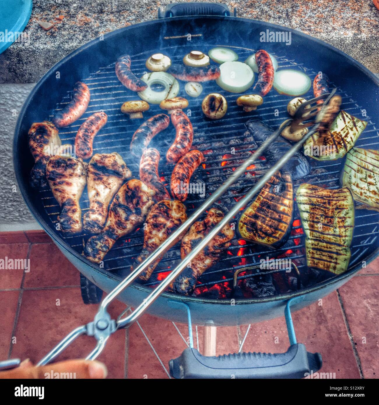 Barbecuing hi-res stock photography and images - Alamy