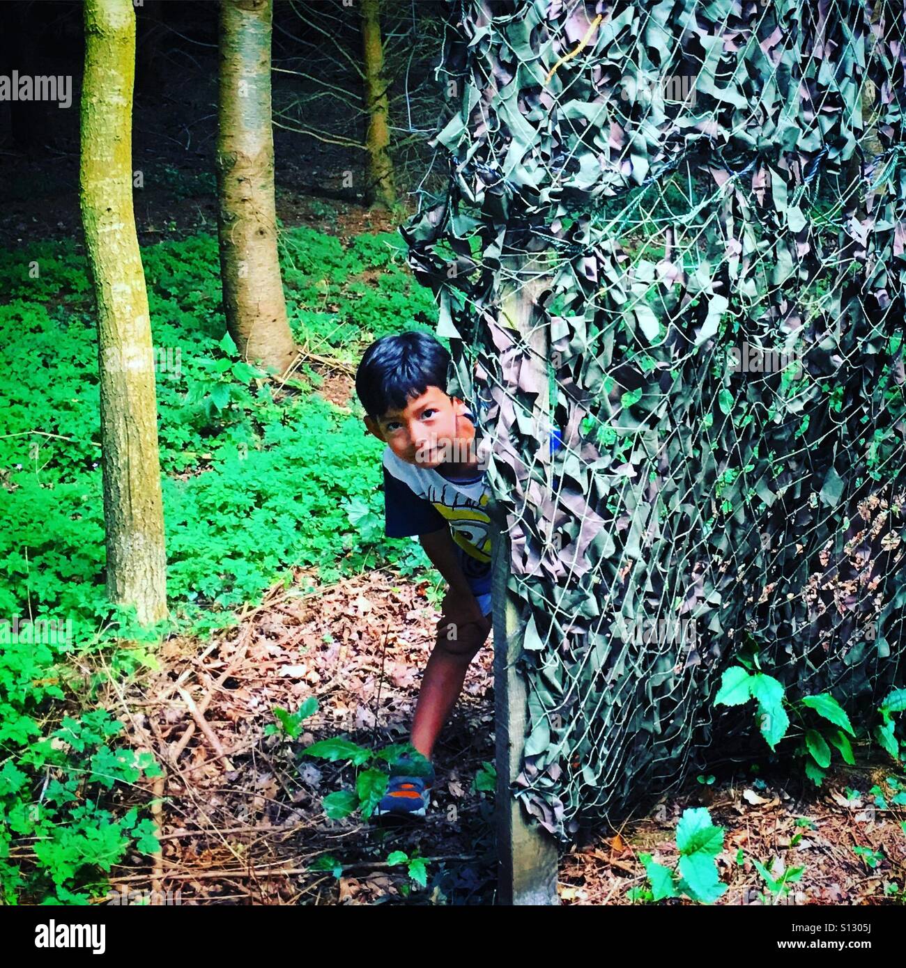 Hiding kid hi-res stock photography and images - Alamy