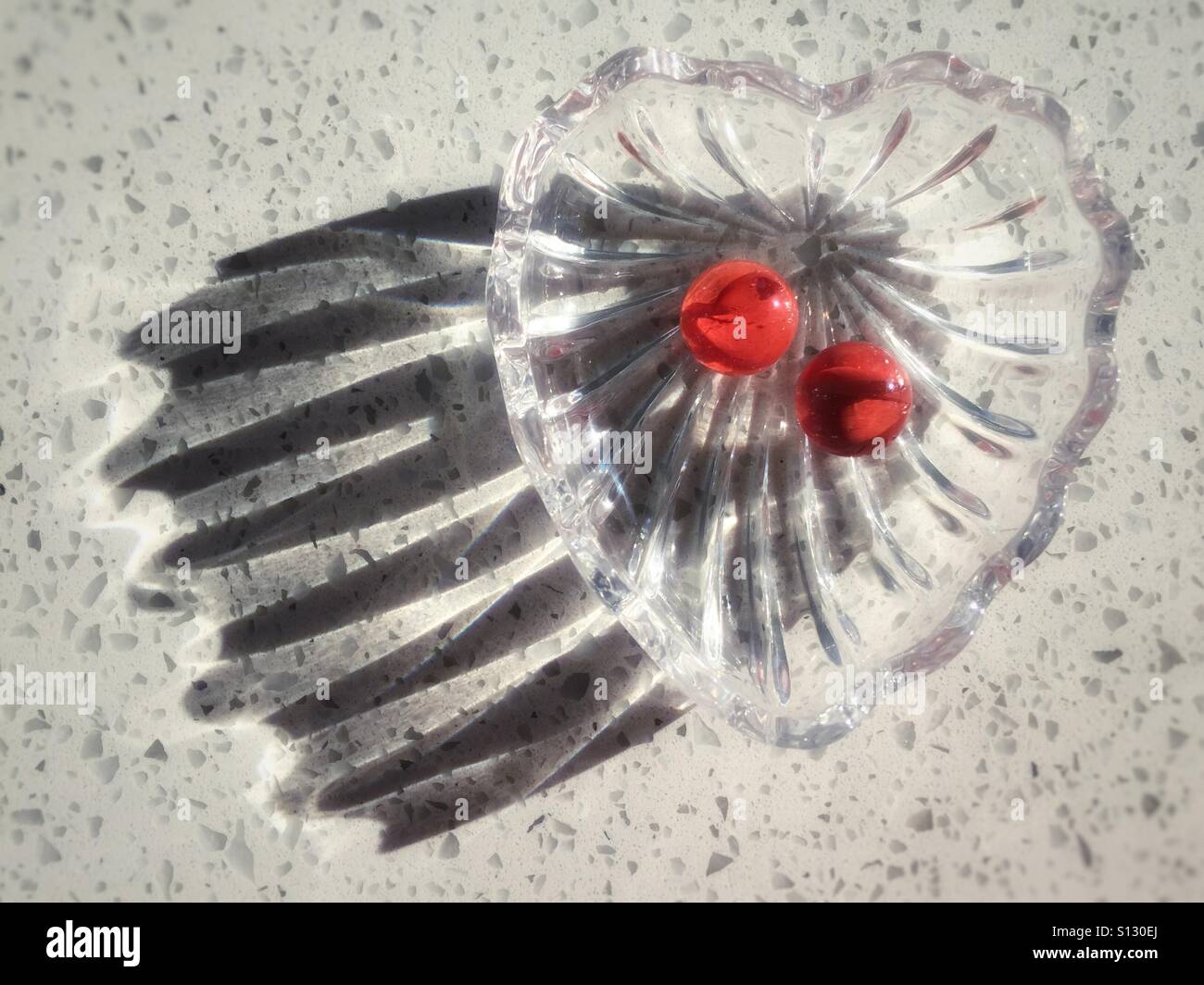 Sunlight through a crystal dish creates an illusion of rocket flames ...