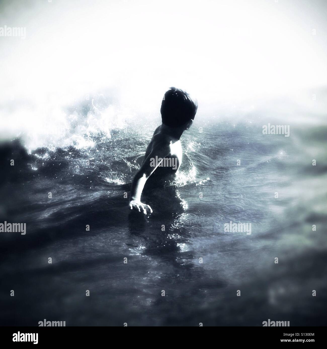 Boy in ocean Stock Photo - Alamy