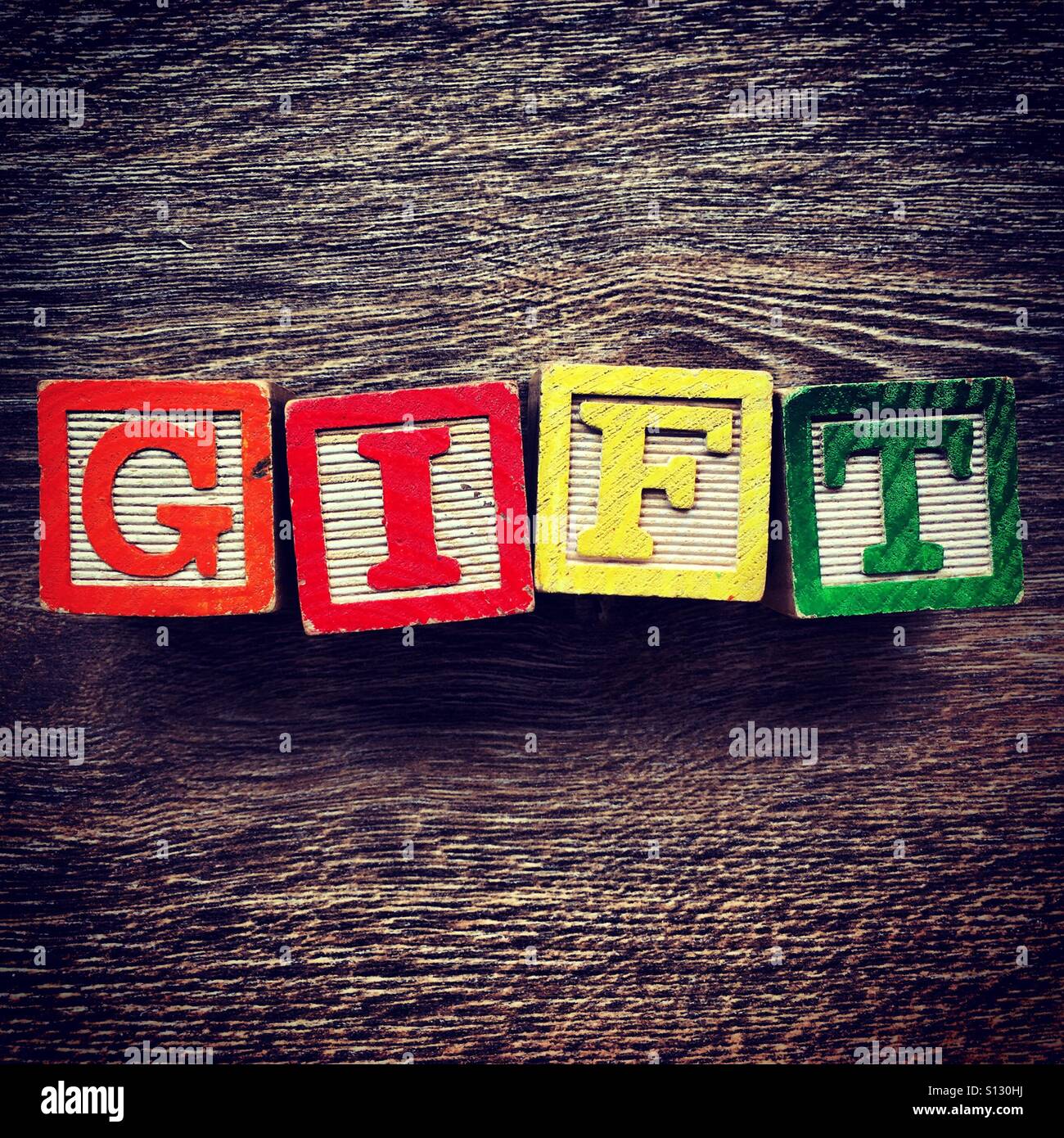 GIFT word written with wood block letter toys Stock Photo - Alamy
