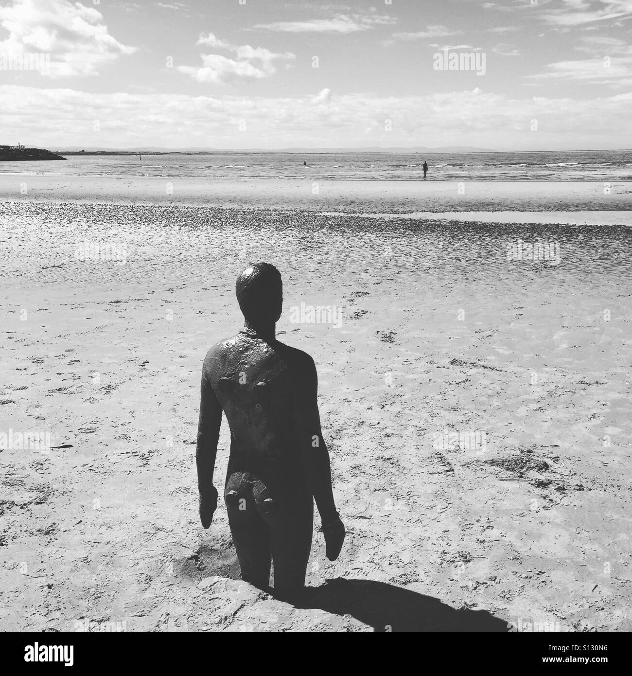 Iron man by Anthony Gormley at Crosby Beach Liverpool Stock Photo - Alamy