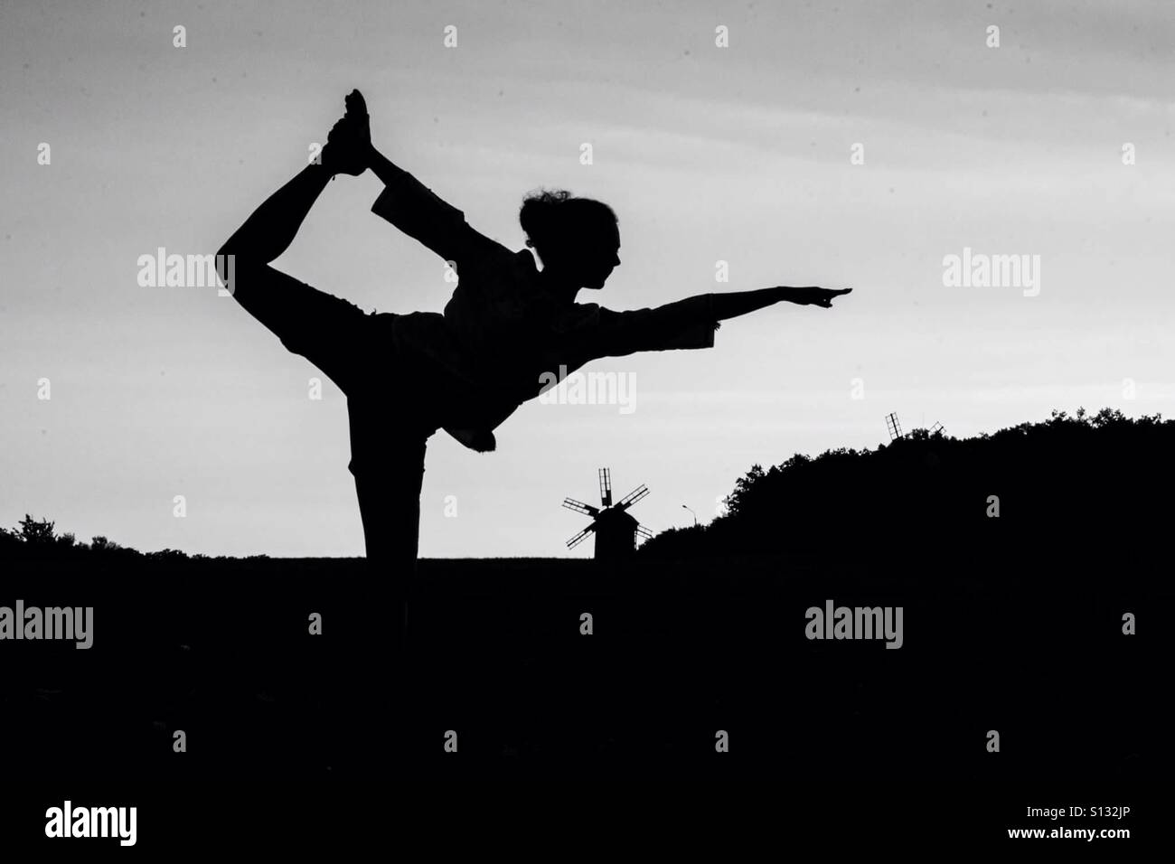 Silhouette of the woman making Natarajasana yoga pose, black and white ...