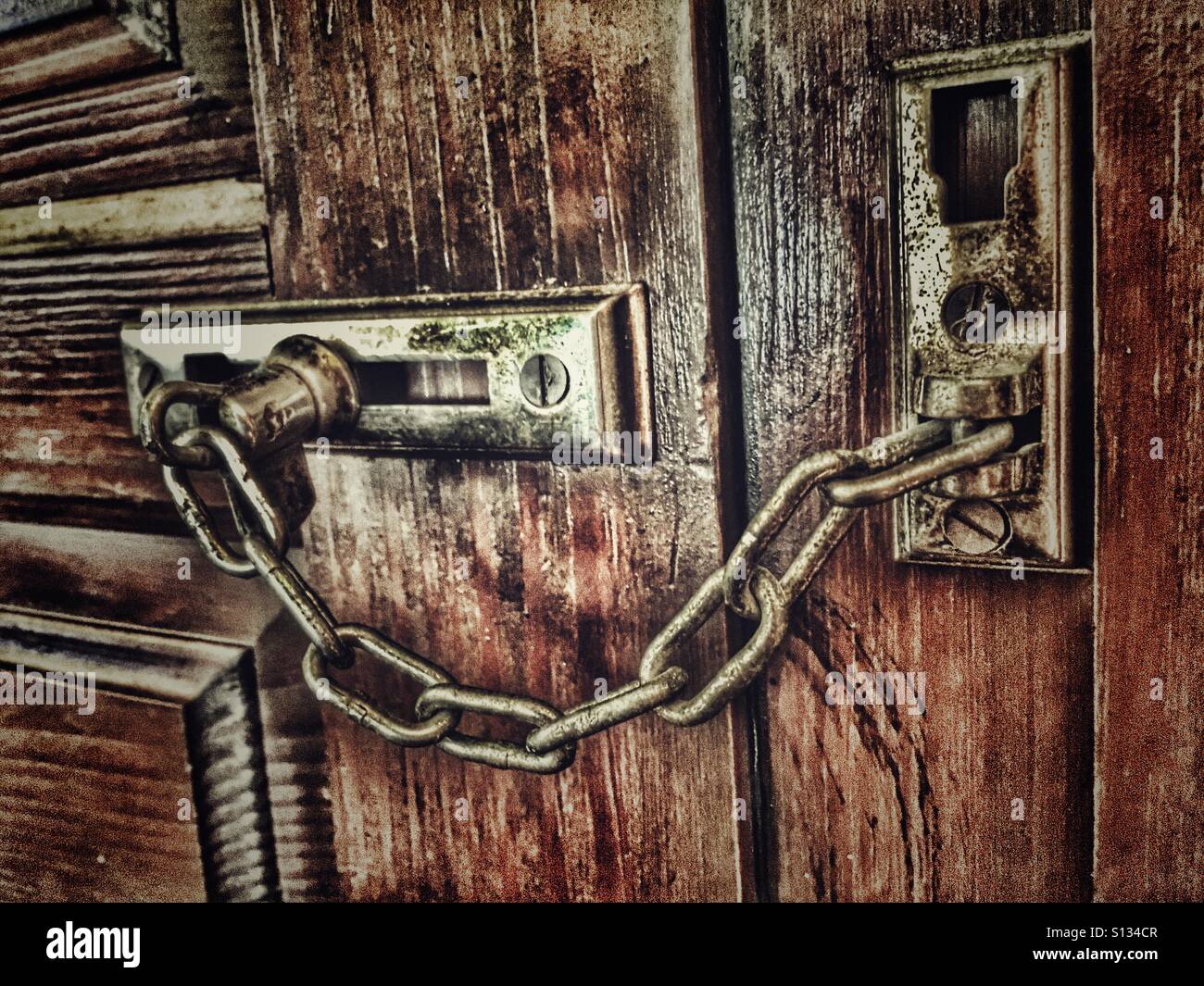 Bolt and chain on front door Stock Photo - Alamy