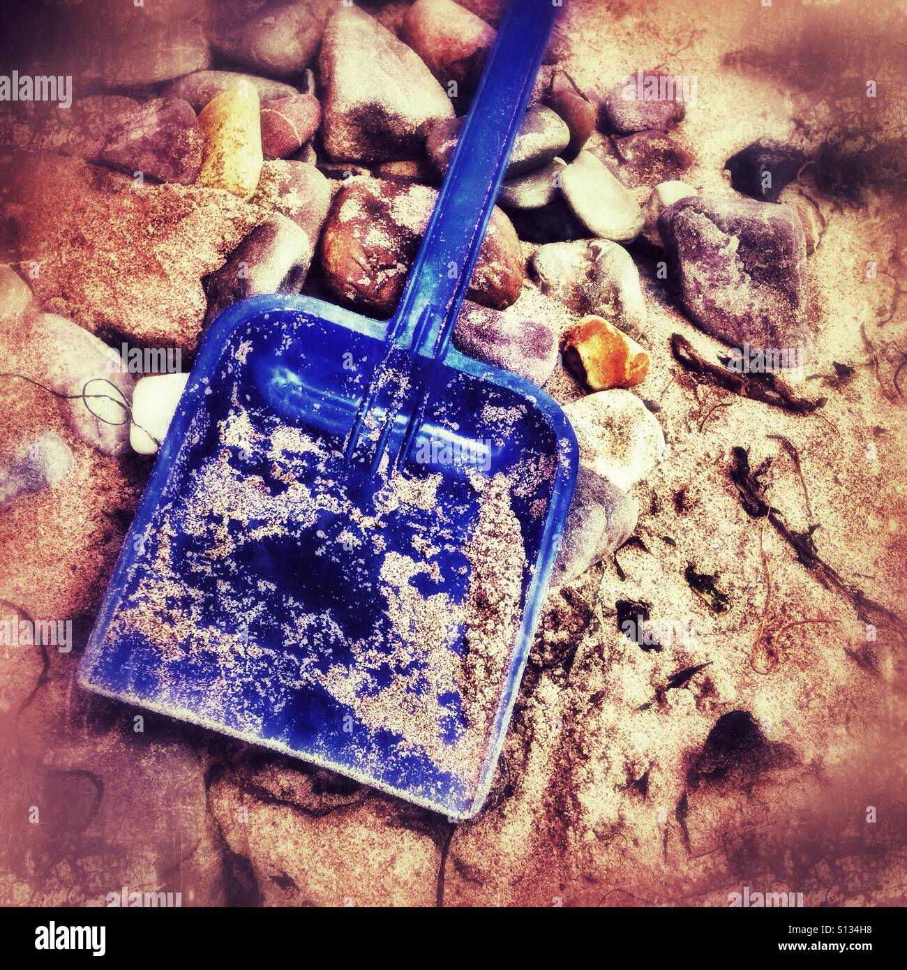 A plastic spade on a beach Stock Photo - Alamy
