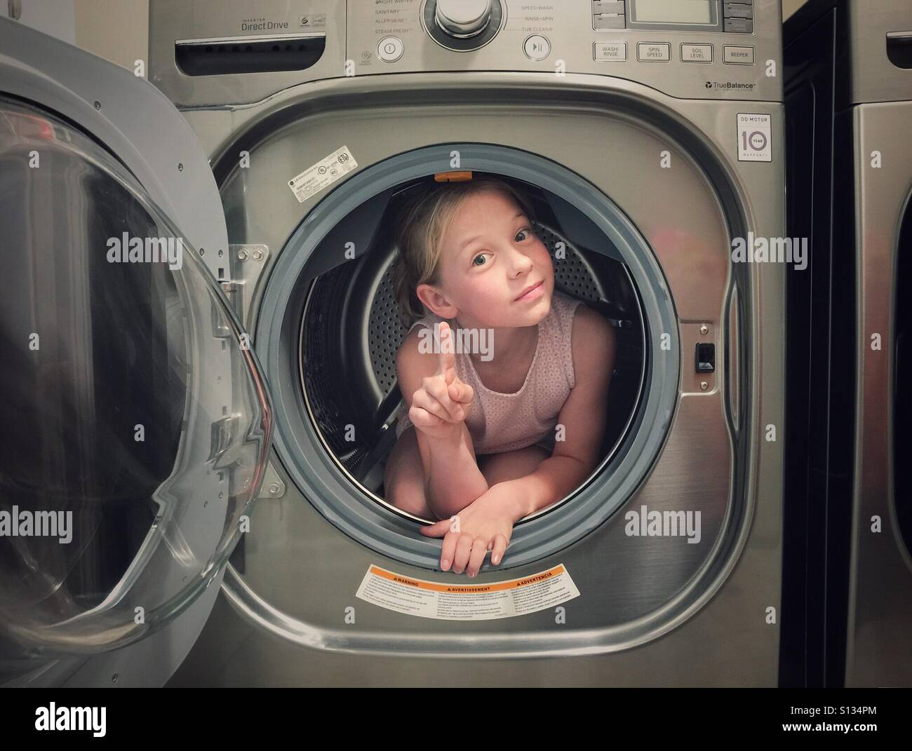 Child girl washing machine hi-res stock photography and images - Alamy