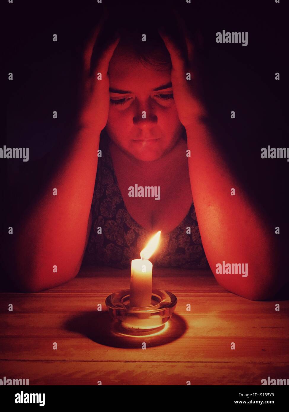 Girl by candlelight, looking thoughtful Stock Photo - Alamy