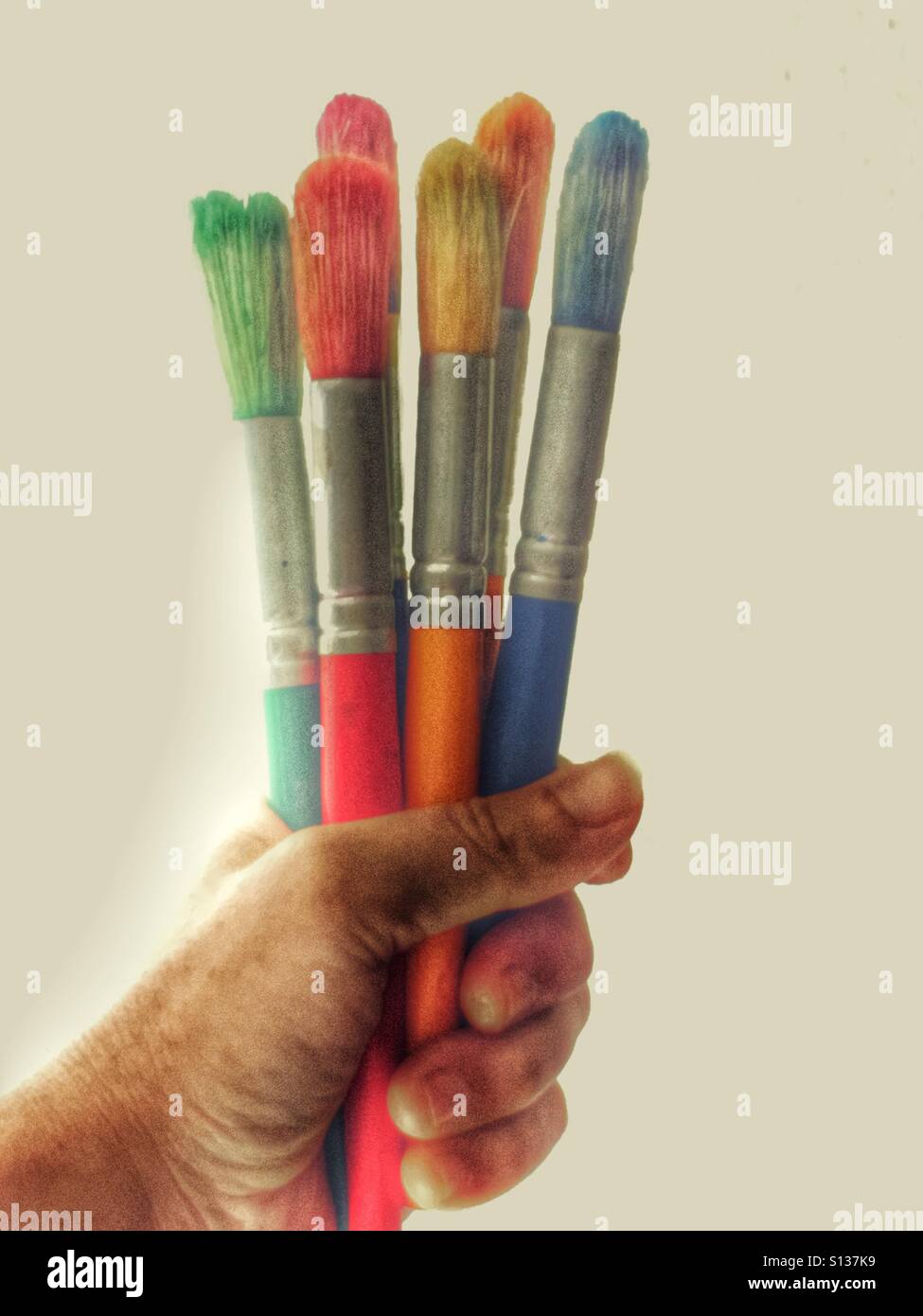 Paint brushes in hand Stock Photo - Alamy