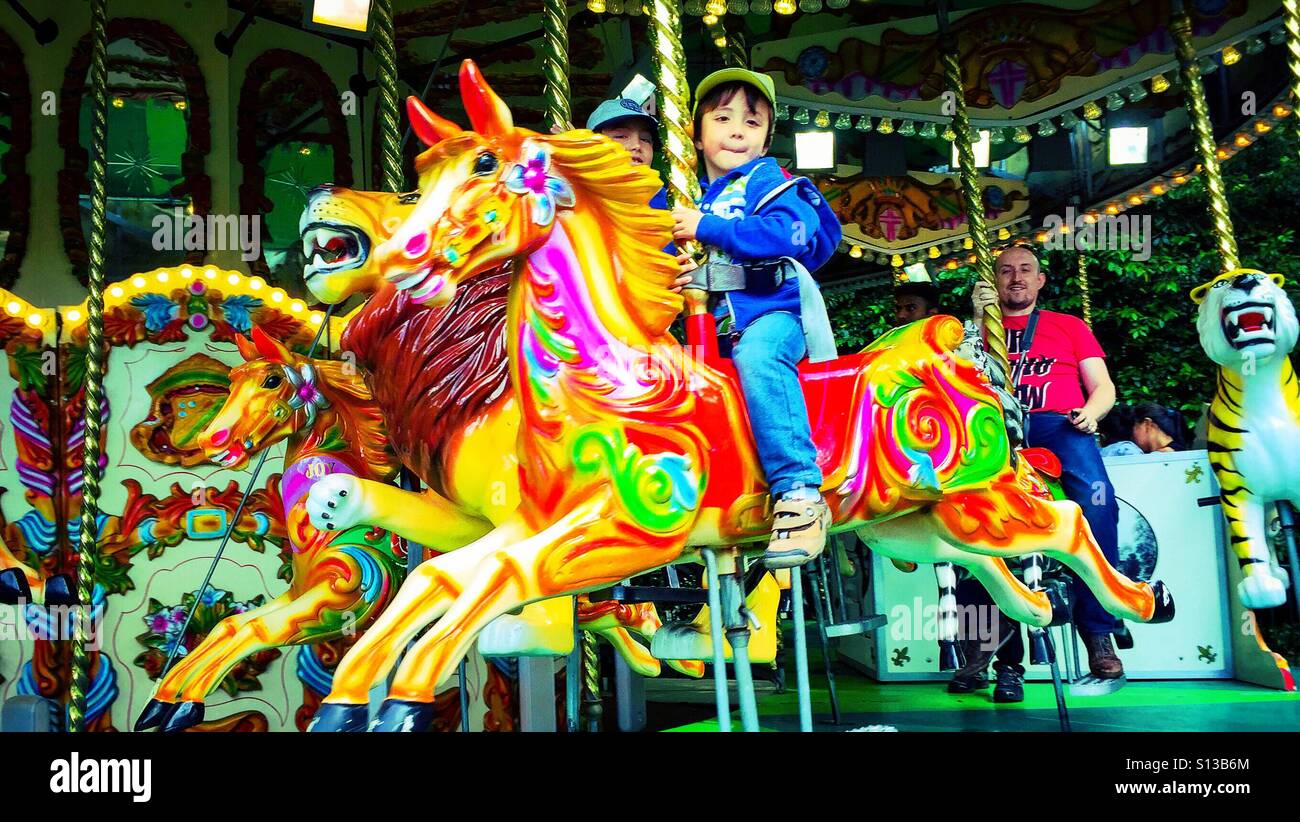 Riding on a carousel Stock Photo - Alamy