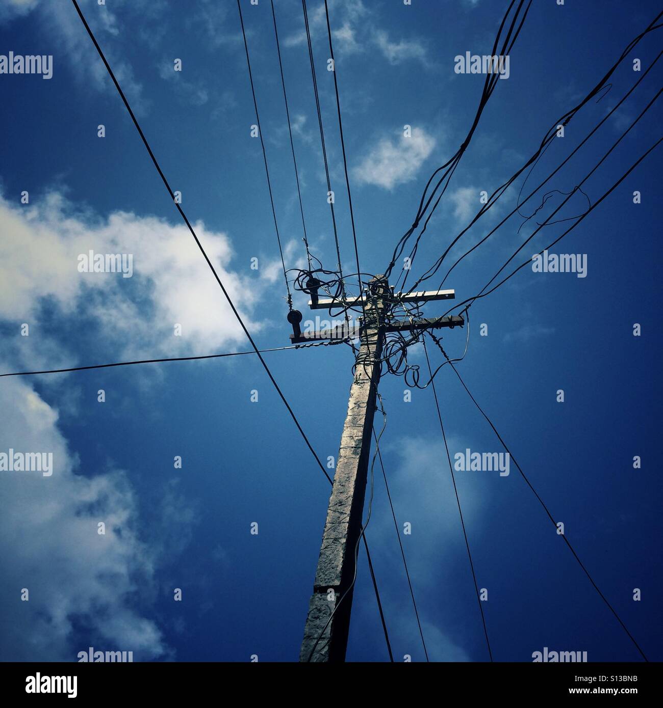 Electric post against sky background Stock Photo - Alamy