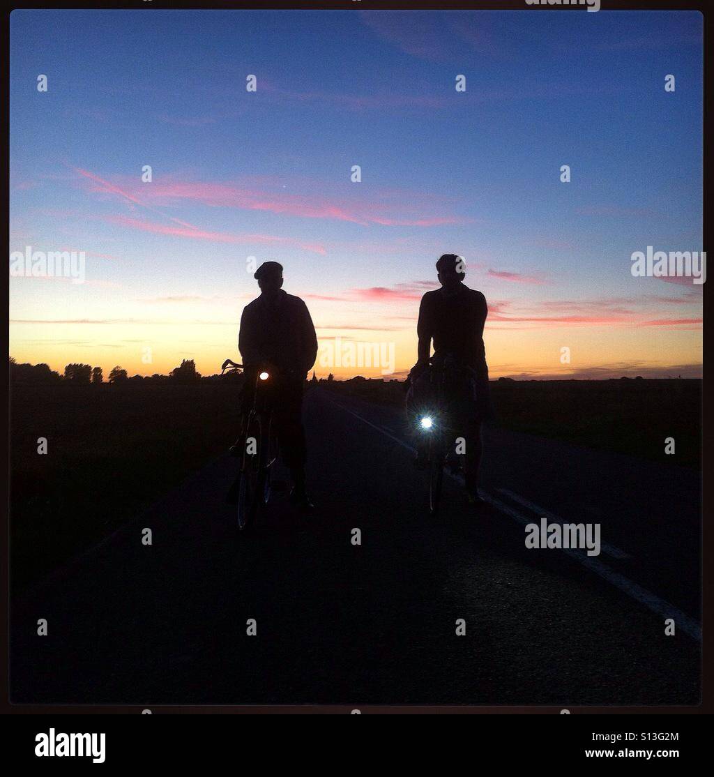Sunset silhouette cycle touring Stock Photo - Alamy