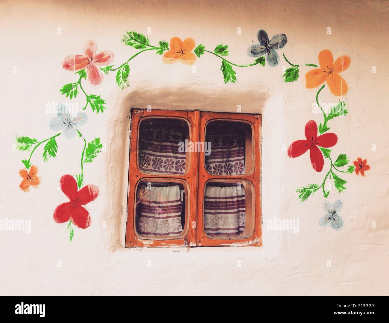 Village style window decorated with flowers Stock Photo - Alamy