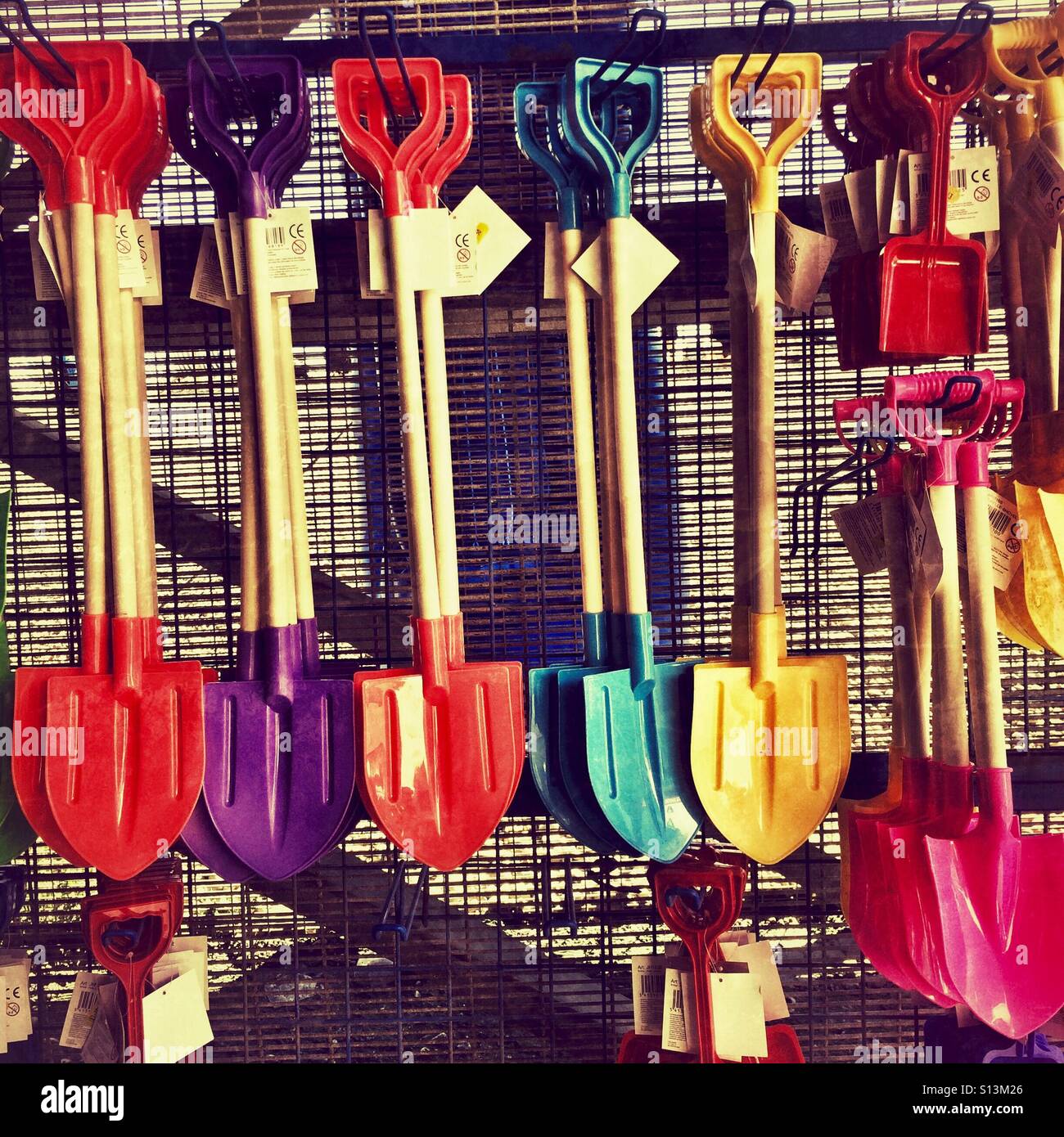 Colourful spades at a beach stall Stock Photo - Alamy