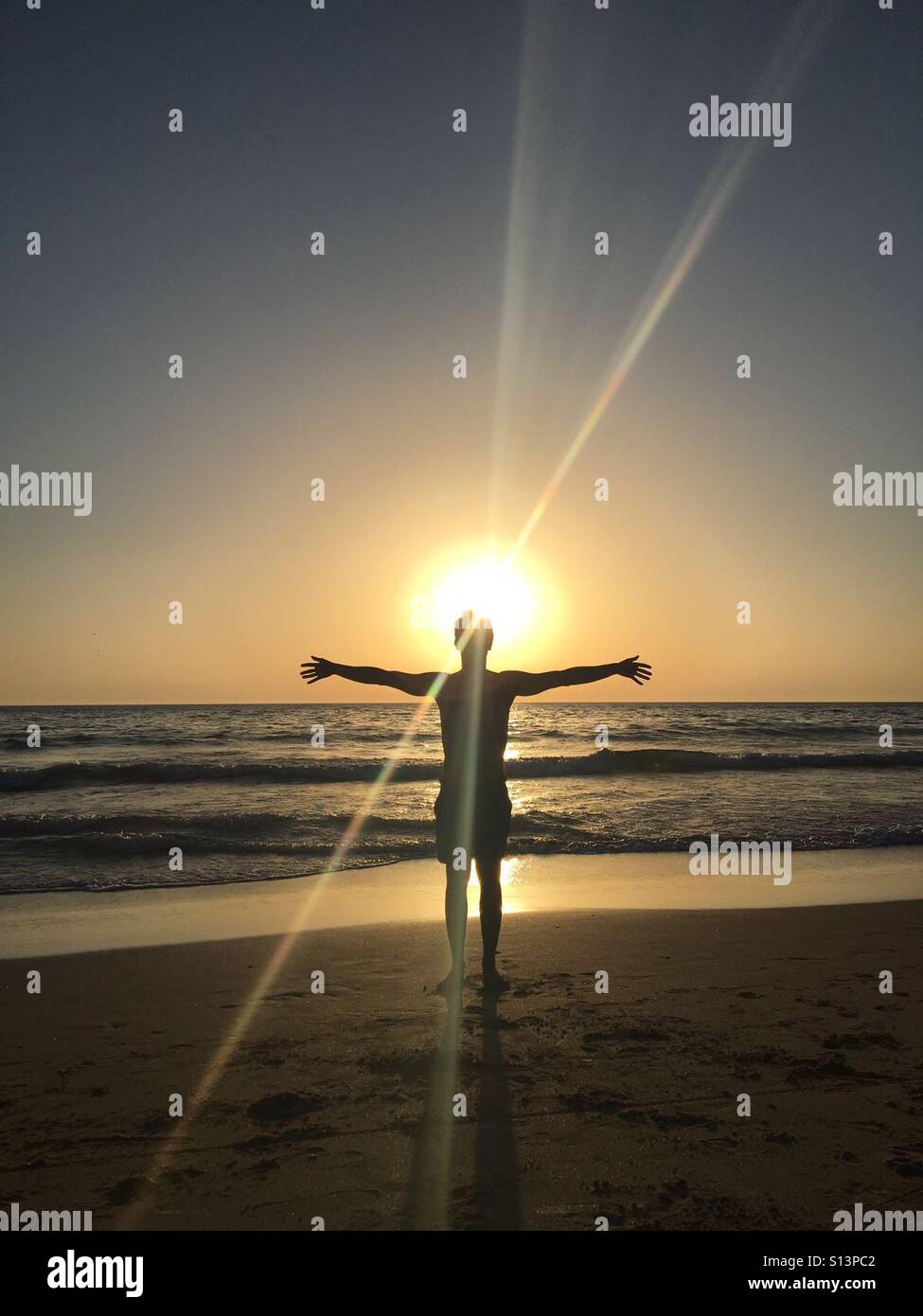 Open arms to sunset Stock Photo - Alamy