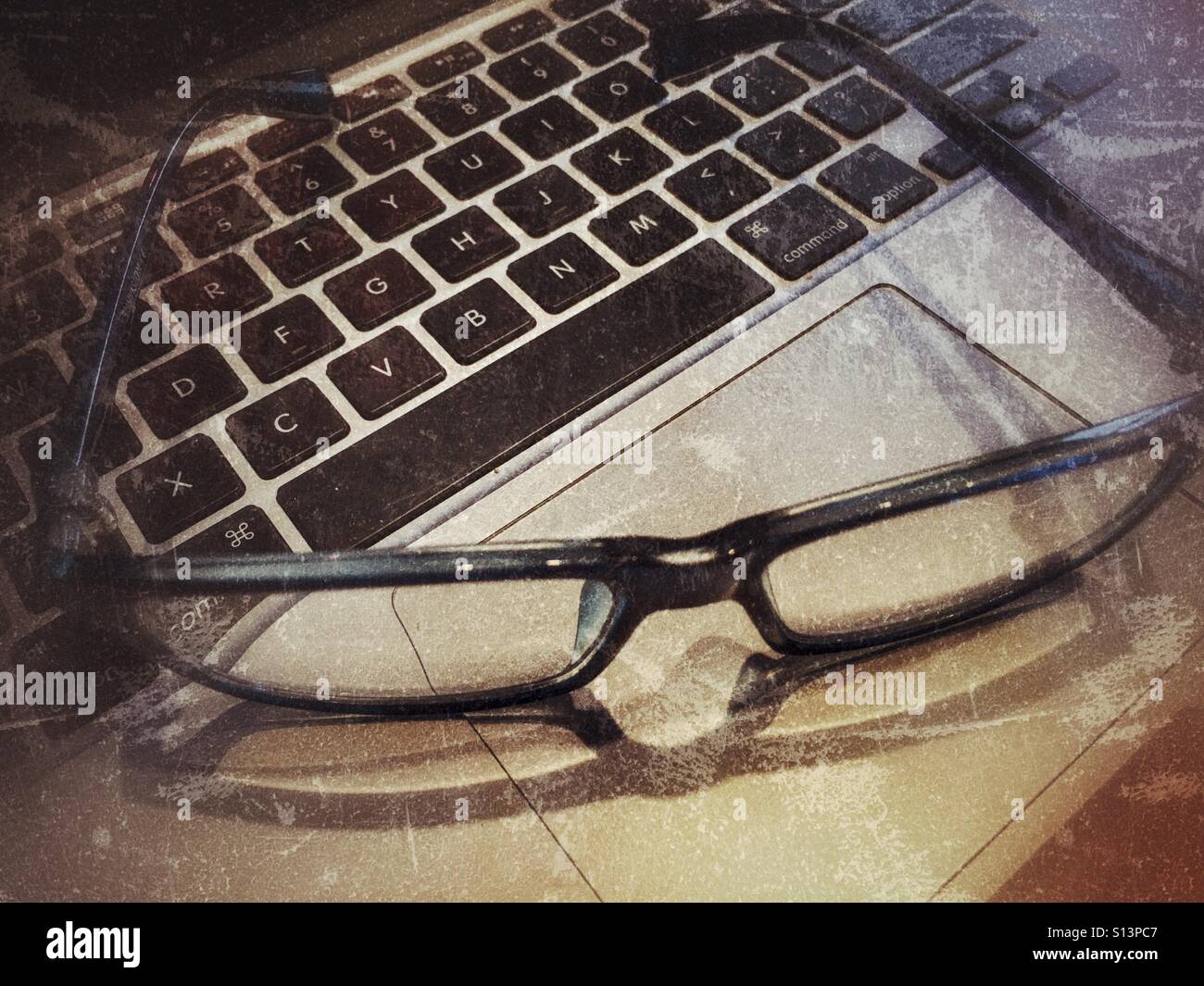 Reading glasses on laptop Stock Photo - Alamy