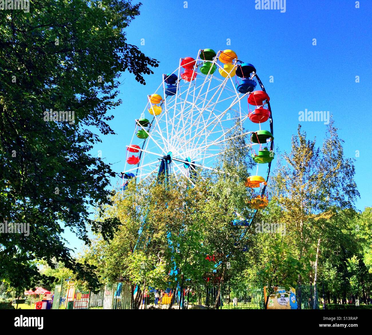 Colorful Ferris wheel in a park Stock Photo - Alamy