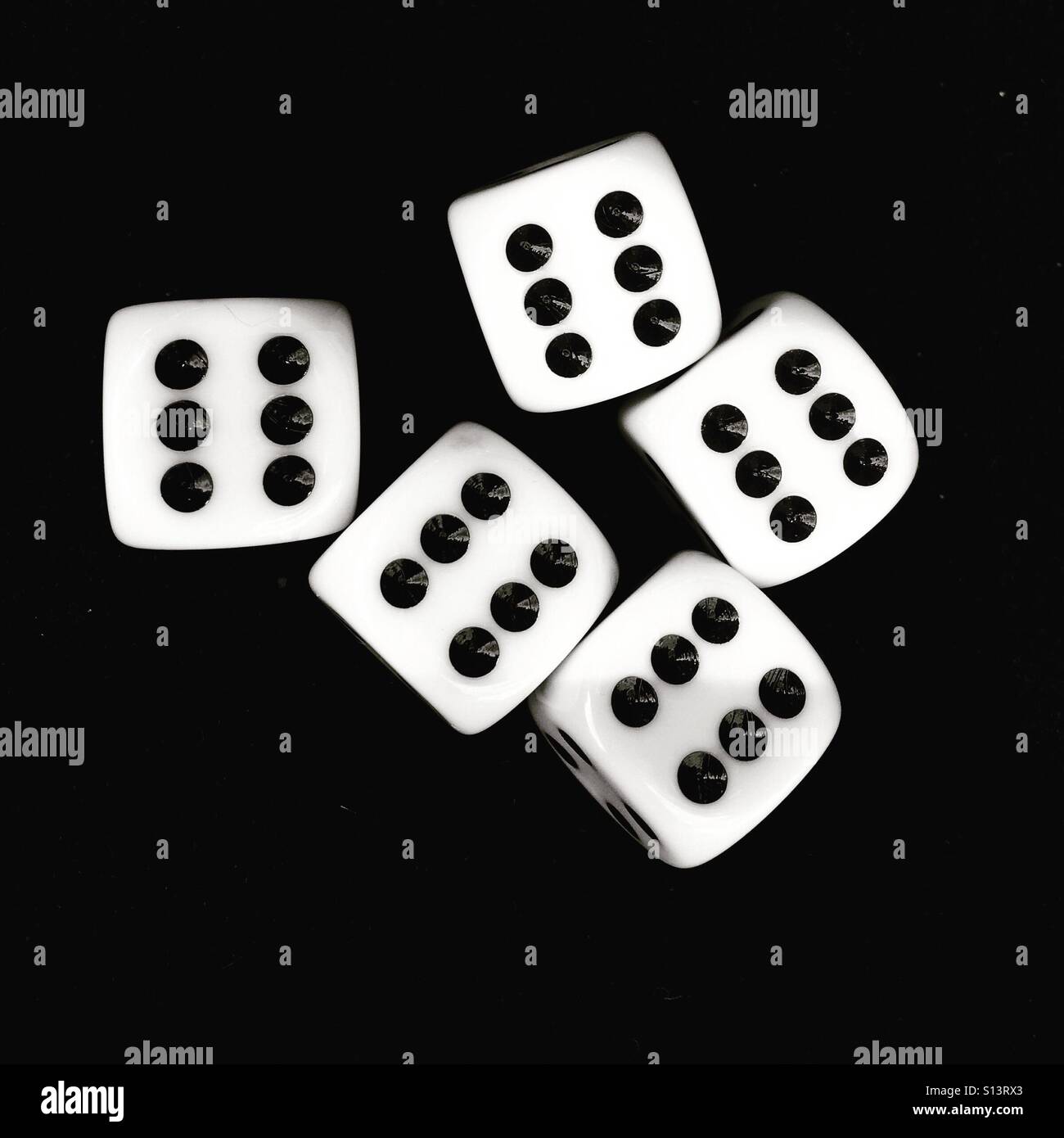 Five dice against black background Stock Photo - Alamy