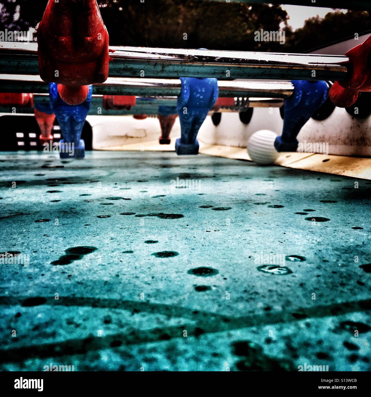 Football table under the rain Stock Photo - Alamy