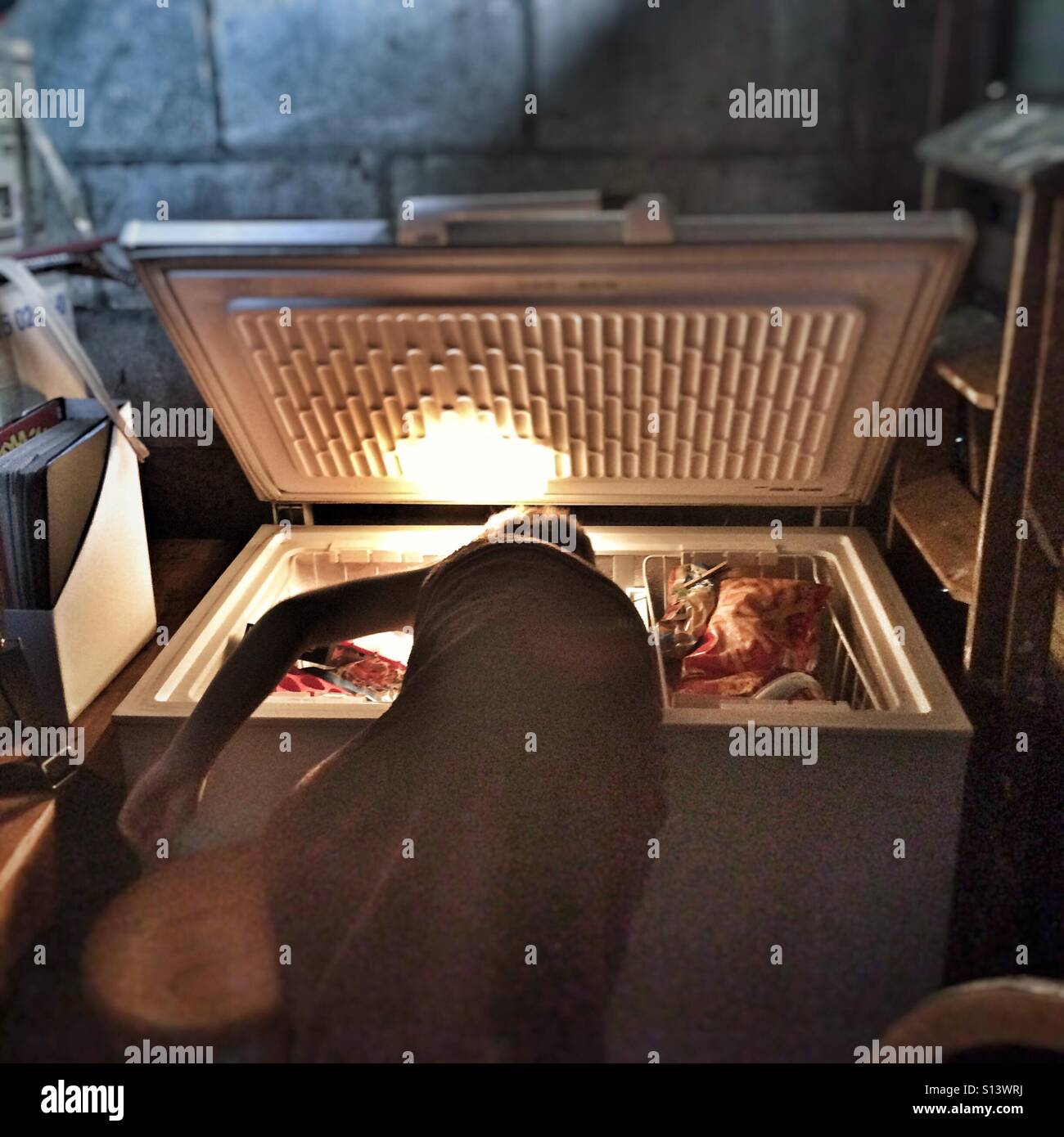 Raiding the freezer for ice-cream Stock Photo - Alamy