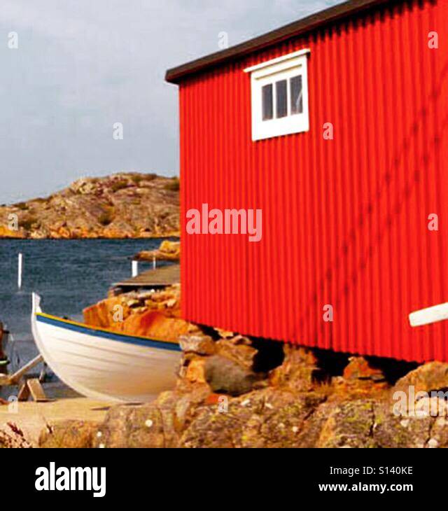 Boat and red hut Stock Photo - Alamy