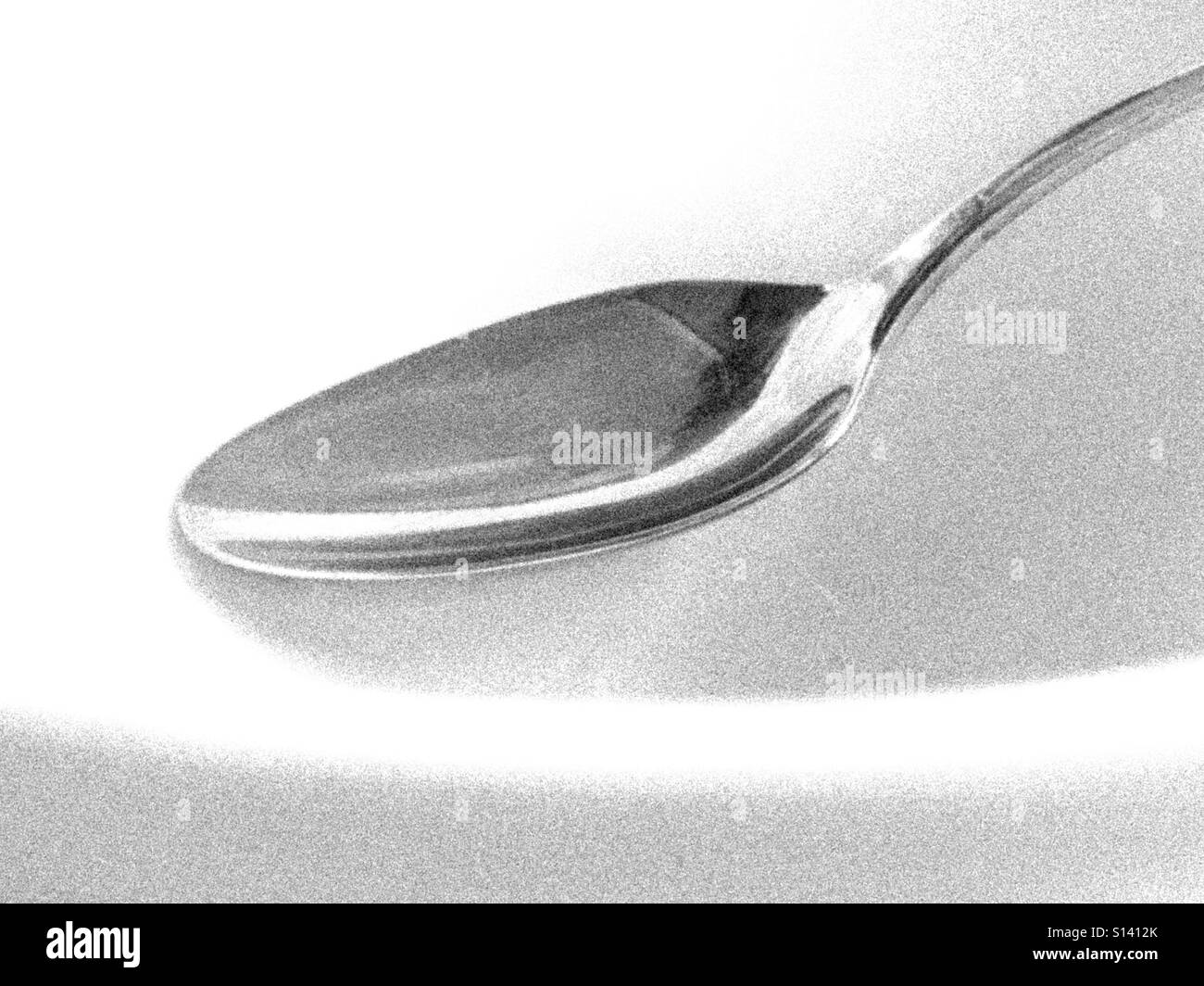 A spoon rests inside an empty bowl Stock Photo - Alamy