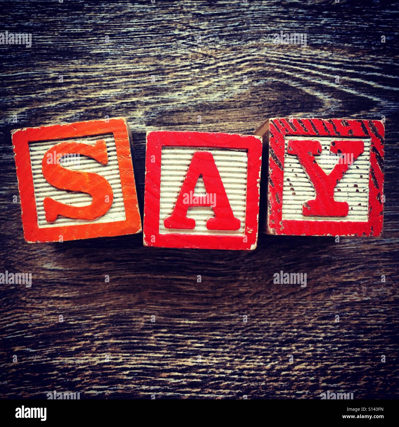 SAY word written with wood block letter toys Stock Photo - Alamy