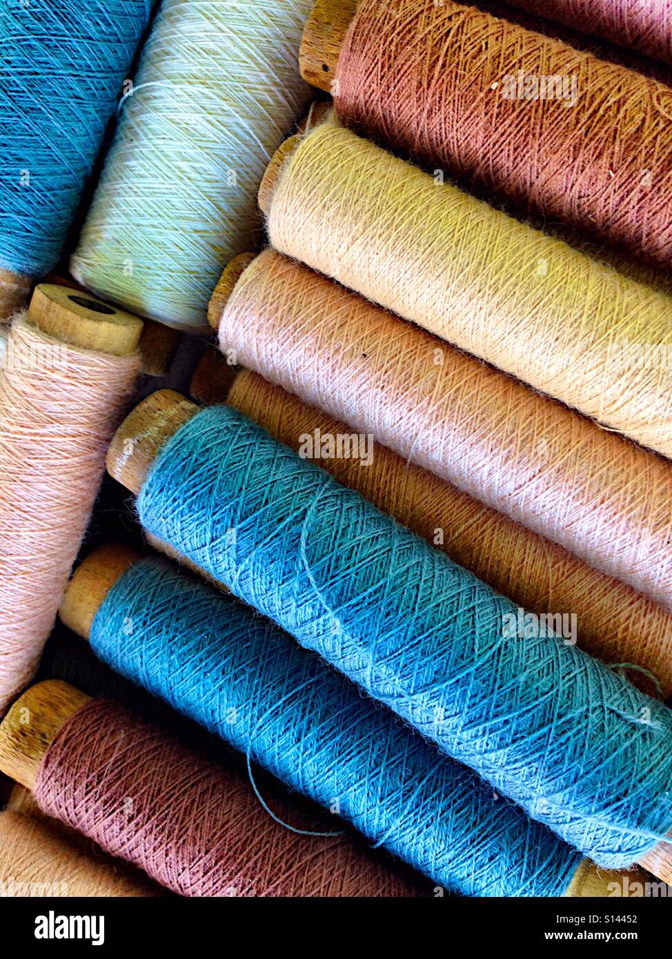 Wooden spools of colored thread Stock Photo - Alamy