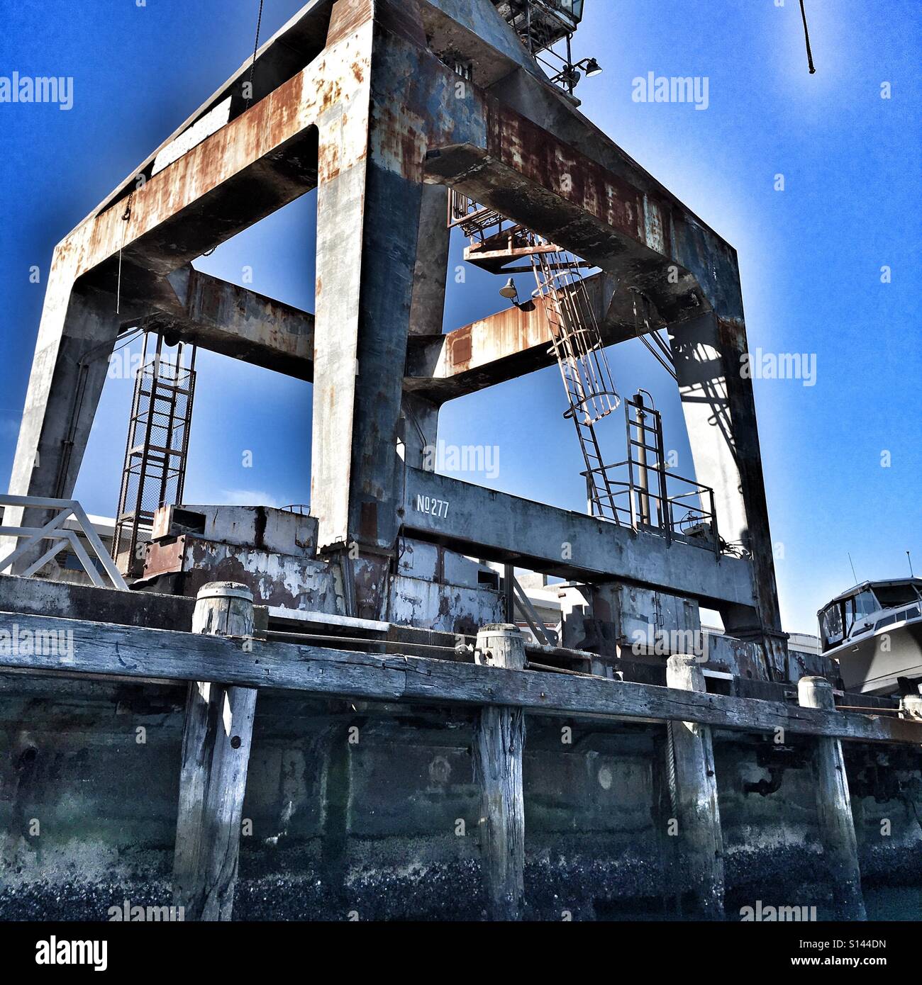 Base of cool old rusty crane against a beautiful blue Sky Stock Photo ...