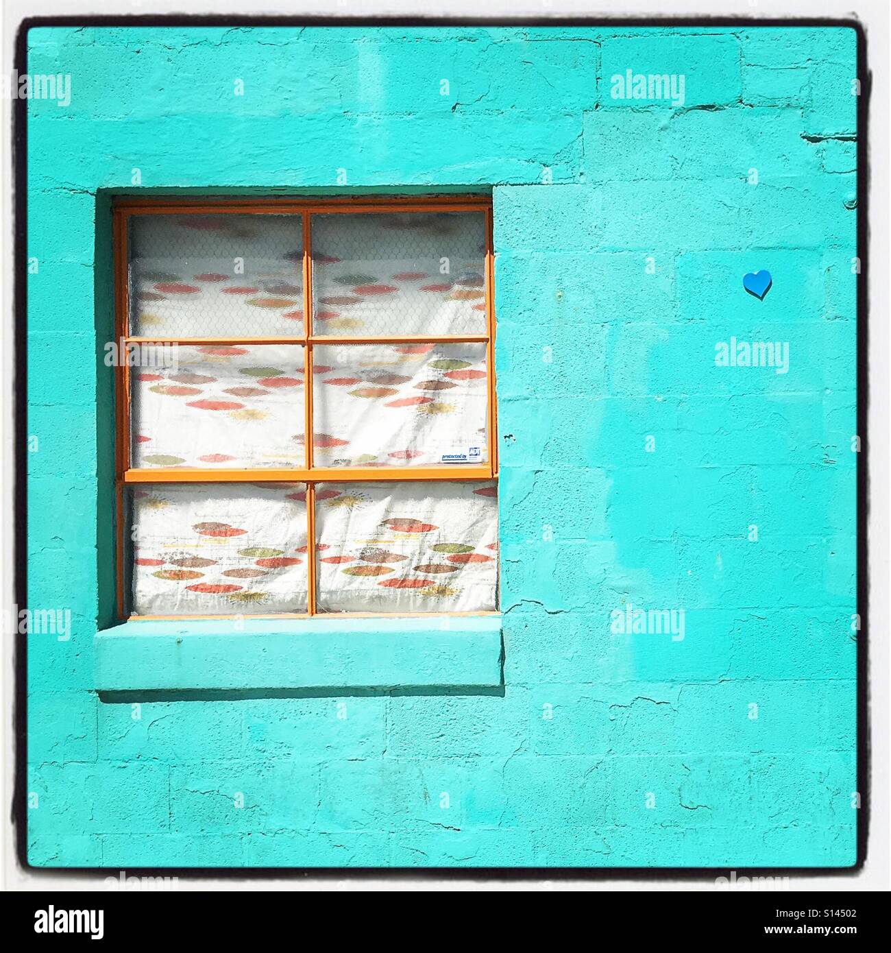 Teal wall with window and heart Stock Photo - Alamy