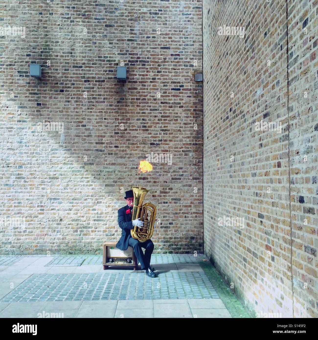 A flame throwing Tuba player busking on the Southbank London UK Stock ...