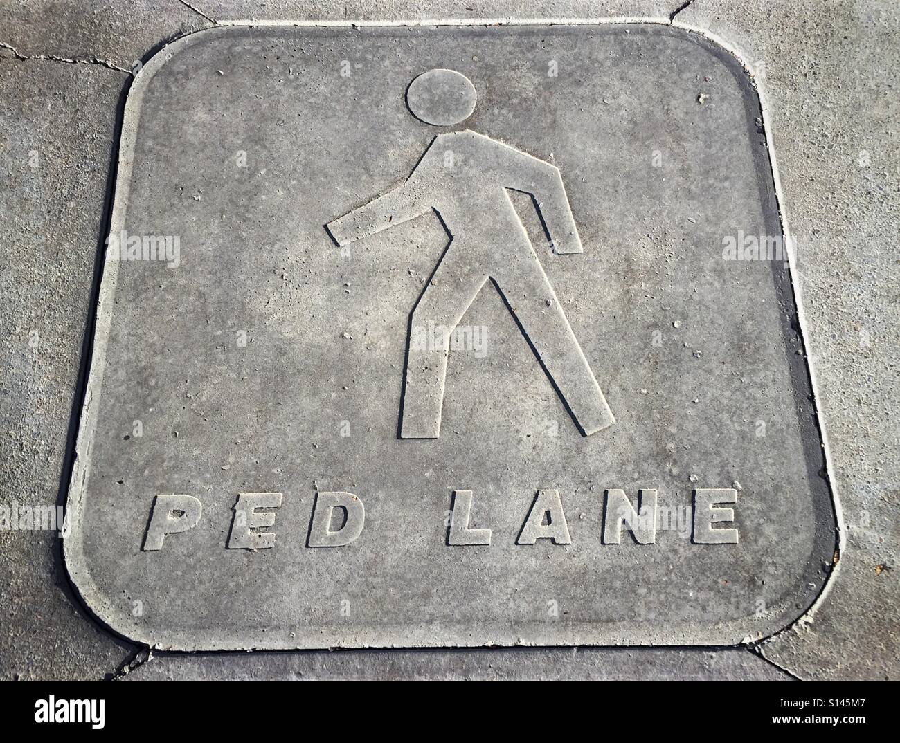 Pedestrian lane sign poured into the concrete of the walkway Stock ...