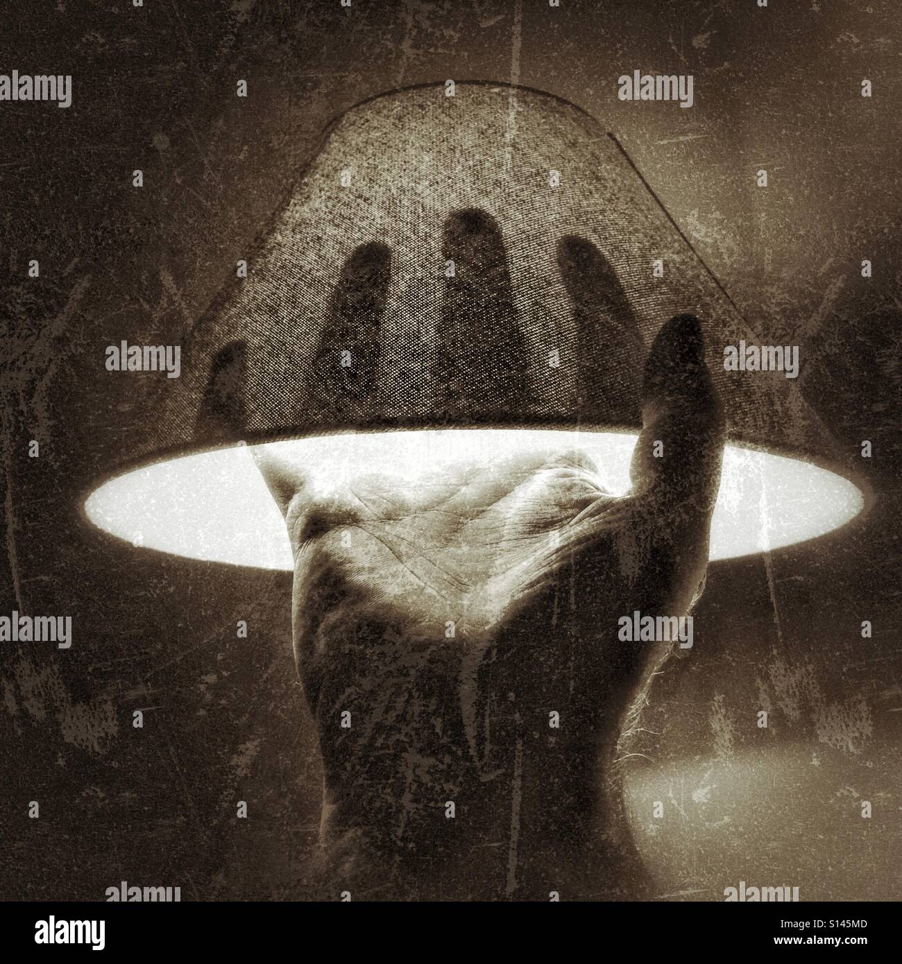 Hand inside lamp Stock Photo - Alamy