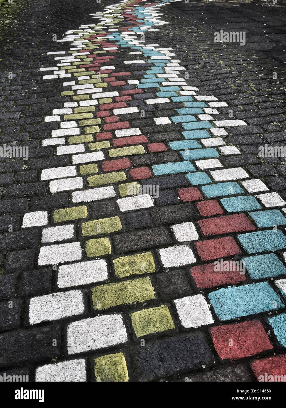 Brightly painted cobblestone path Stock Photo - Alamy