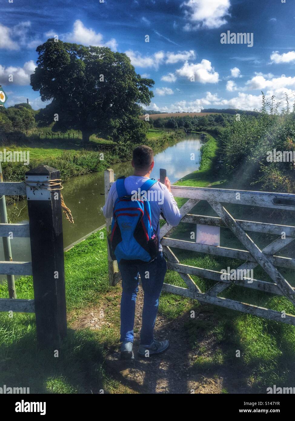 Man pushing gate open Stock Photo - Alamy