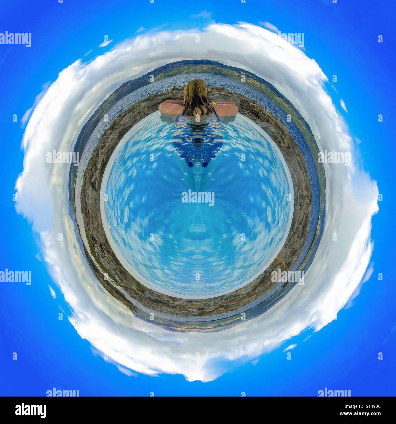 Original Little Planet image of woman looking out of infinity pool ...