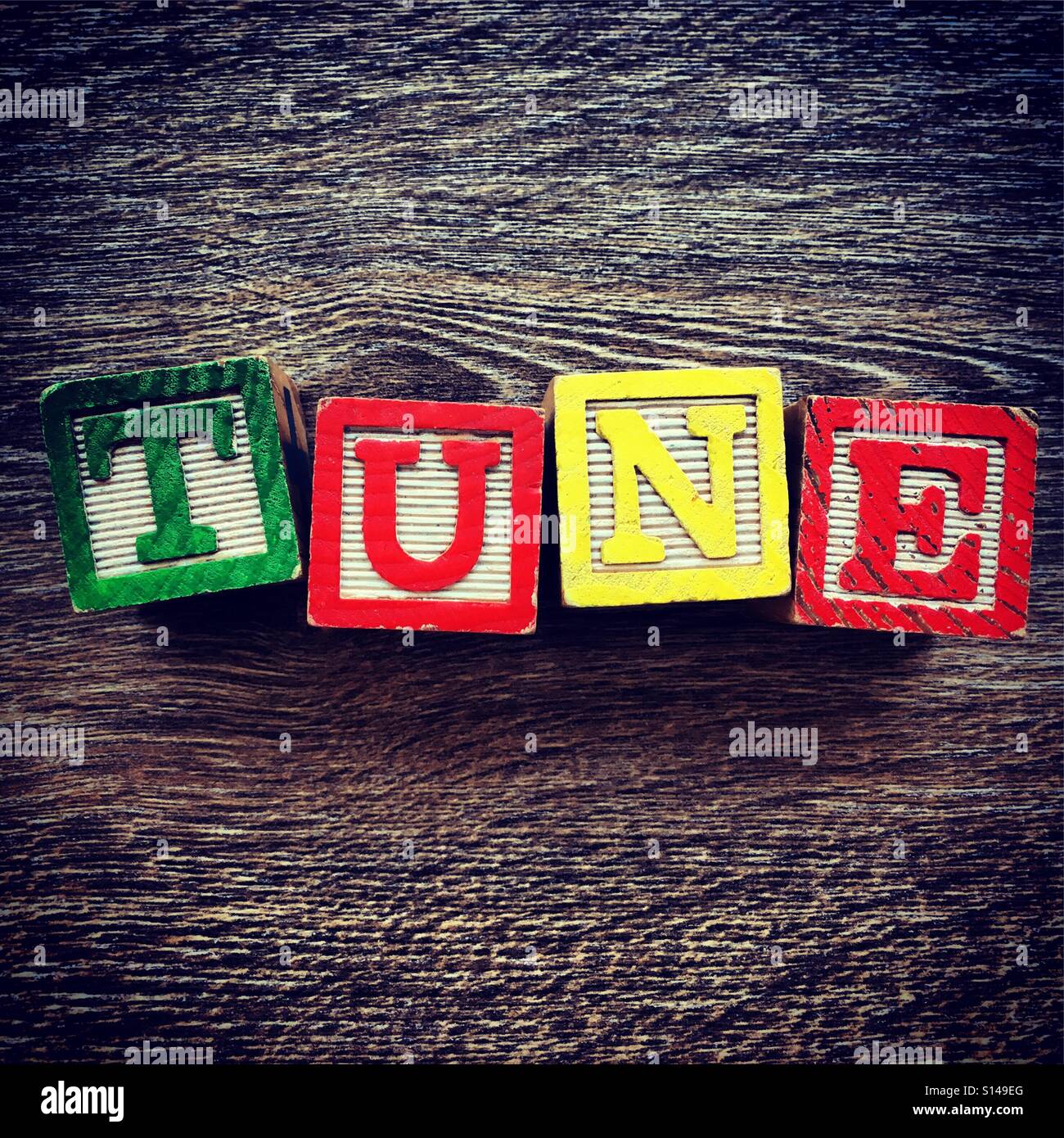 TUNE word written with wood block characters Stock Photo - Alamy
