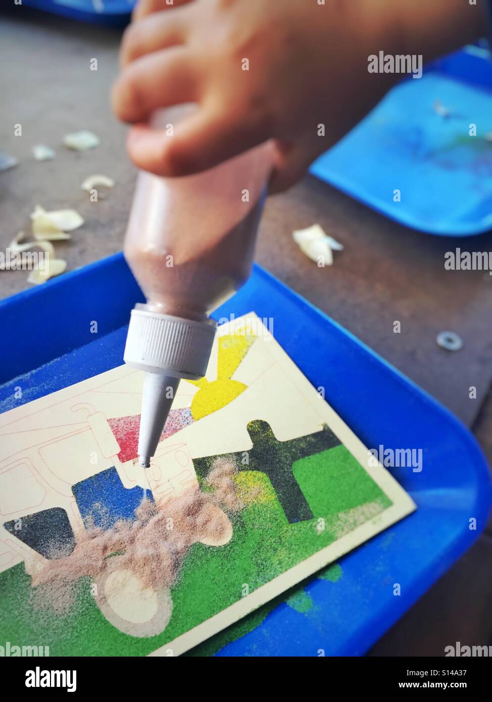 Toddler doing sand art Stock Photo - Alamy