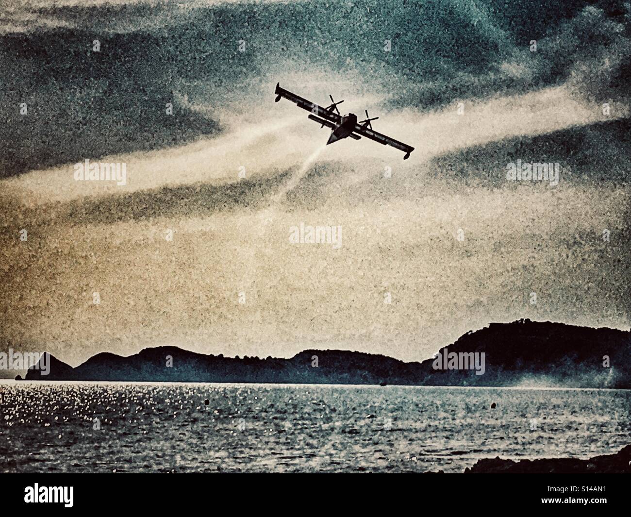 Amphibious fire fighting plane in smoke filled sky, after collecting ...