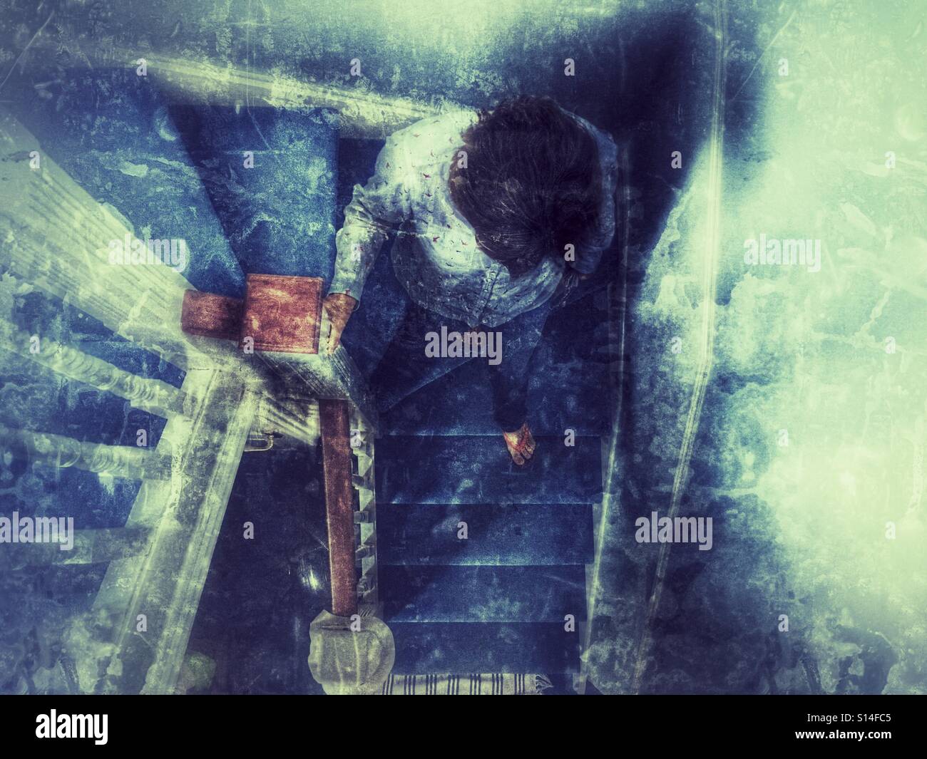 Woman going downstairs Stock Photo - Alamy