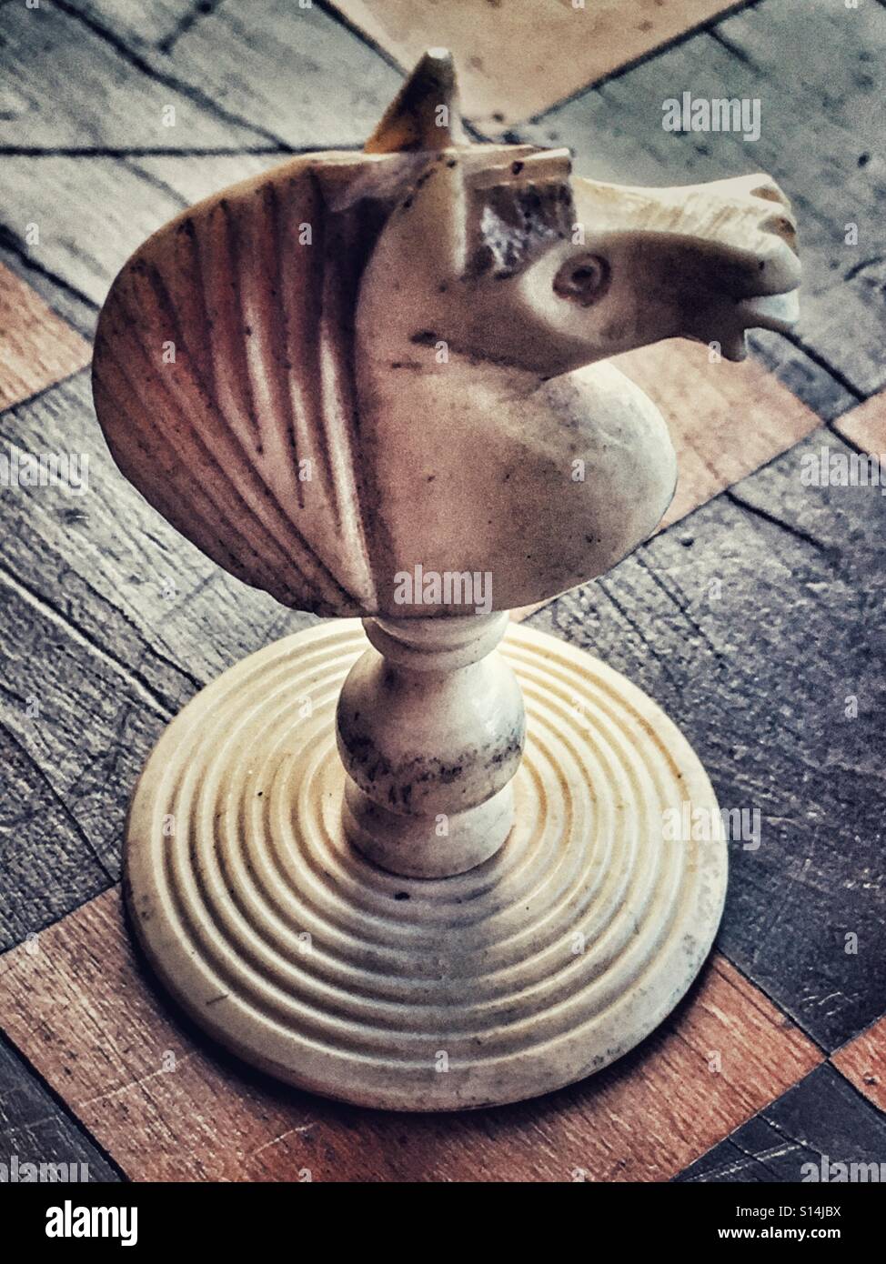 Knight on an antique chess board Stock Photo - Alamy