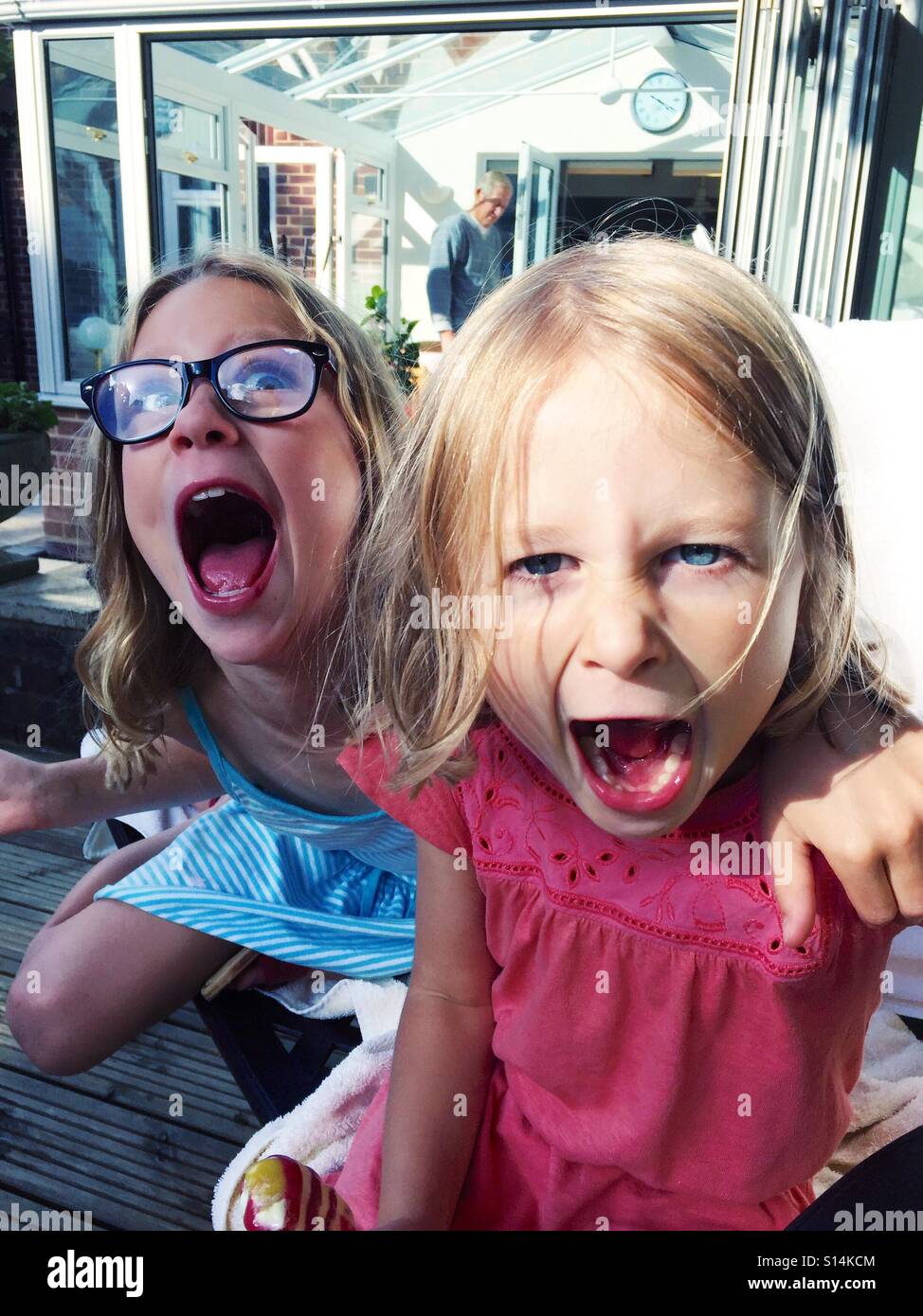 Girls playing faces Stock Photo - Alamy