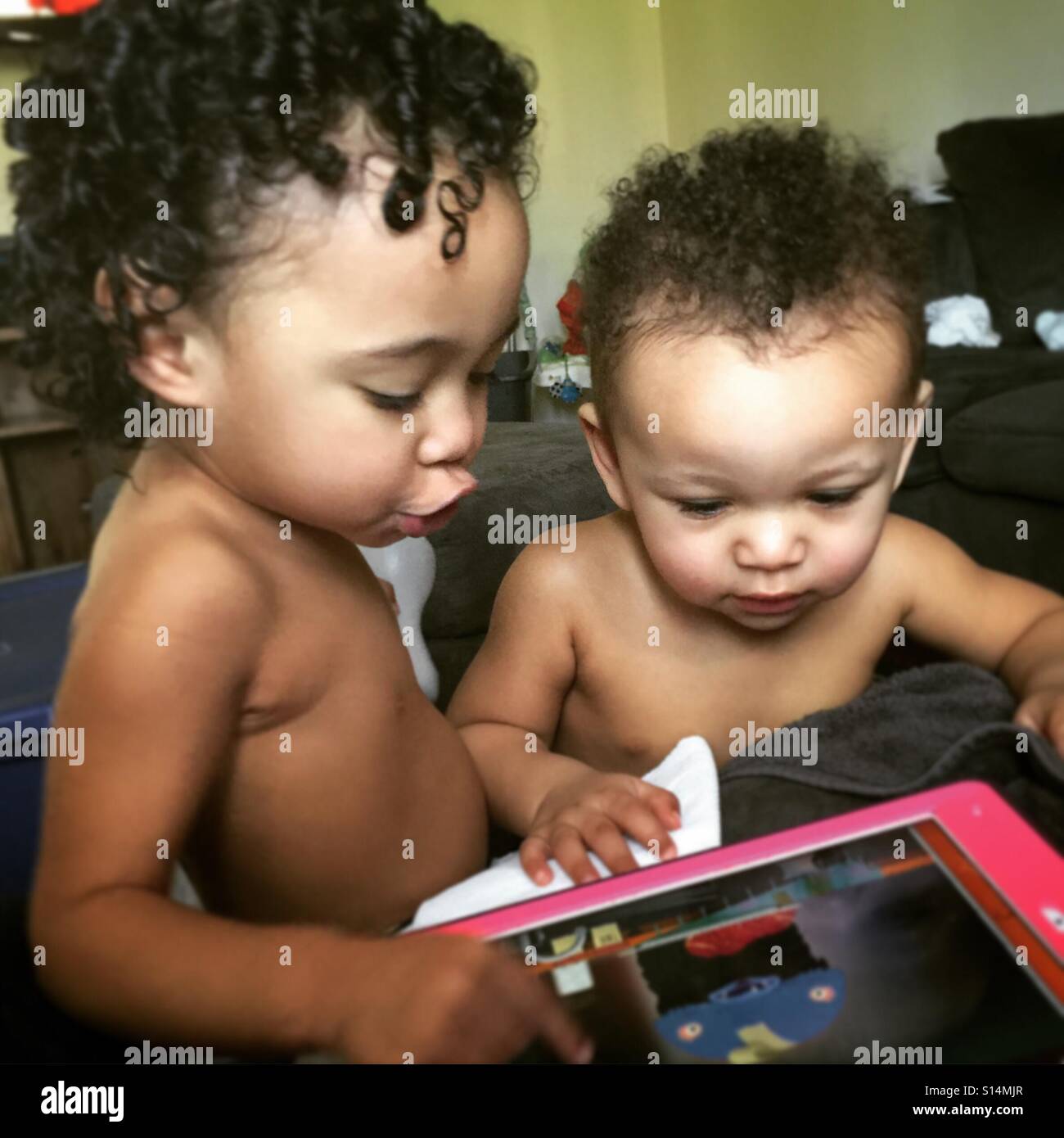 Sharing a game Stock Photo - Alamy