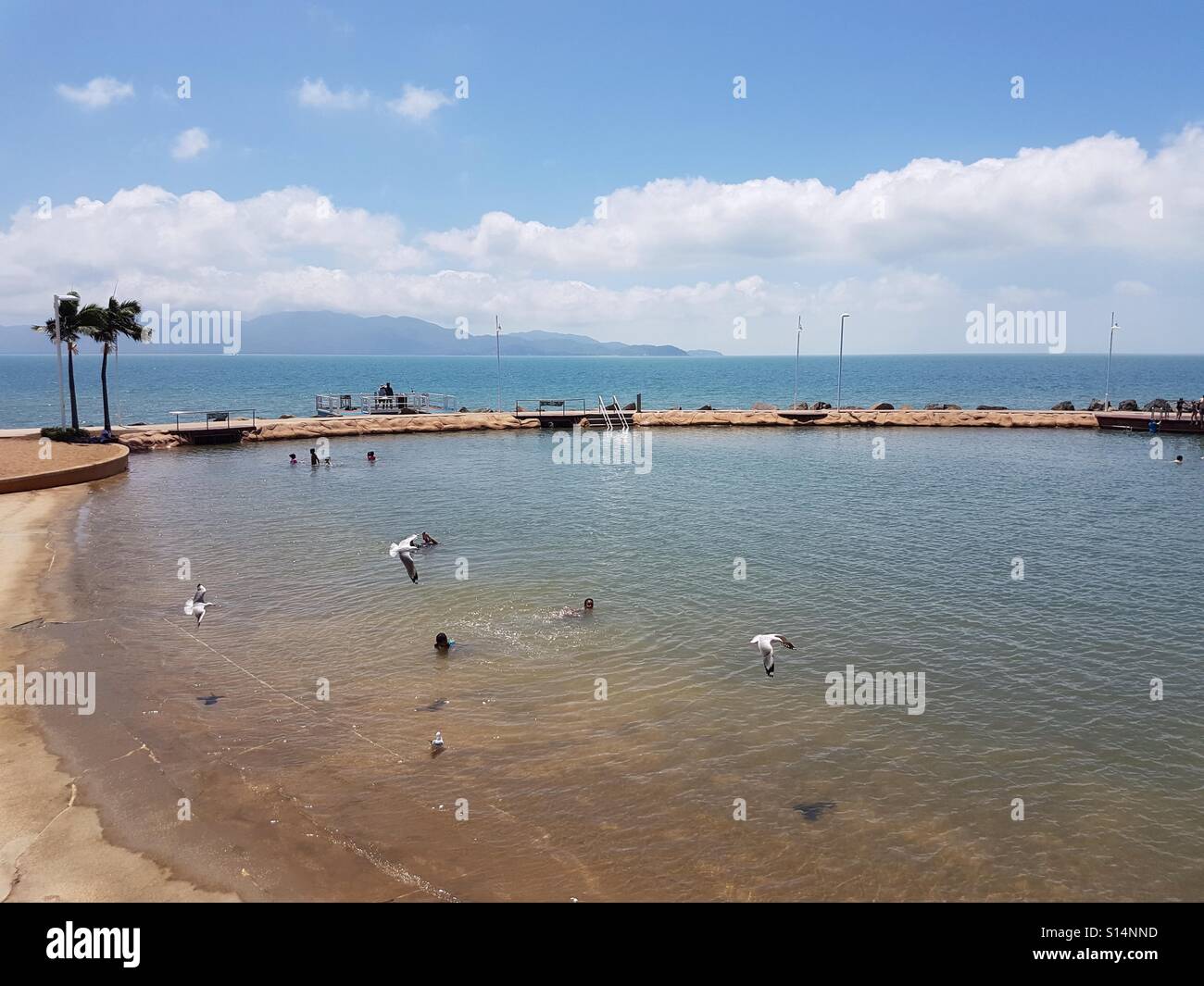 Townsville Rock Pool with Magnetic Island in the background Stock Photo ...
