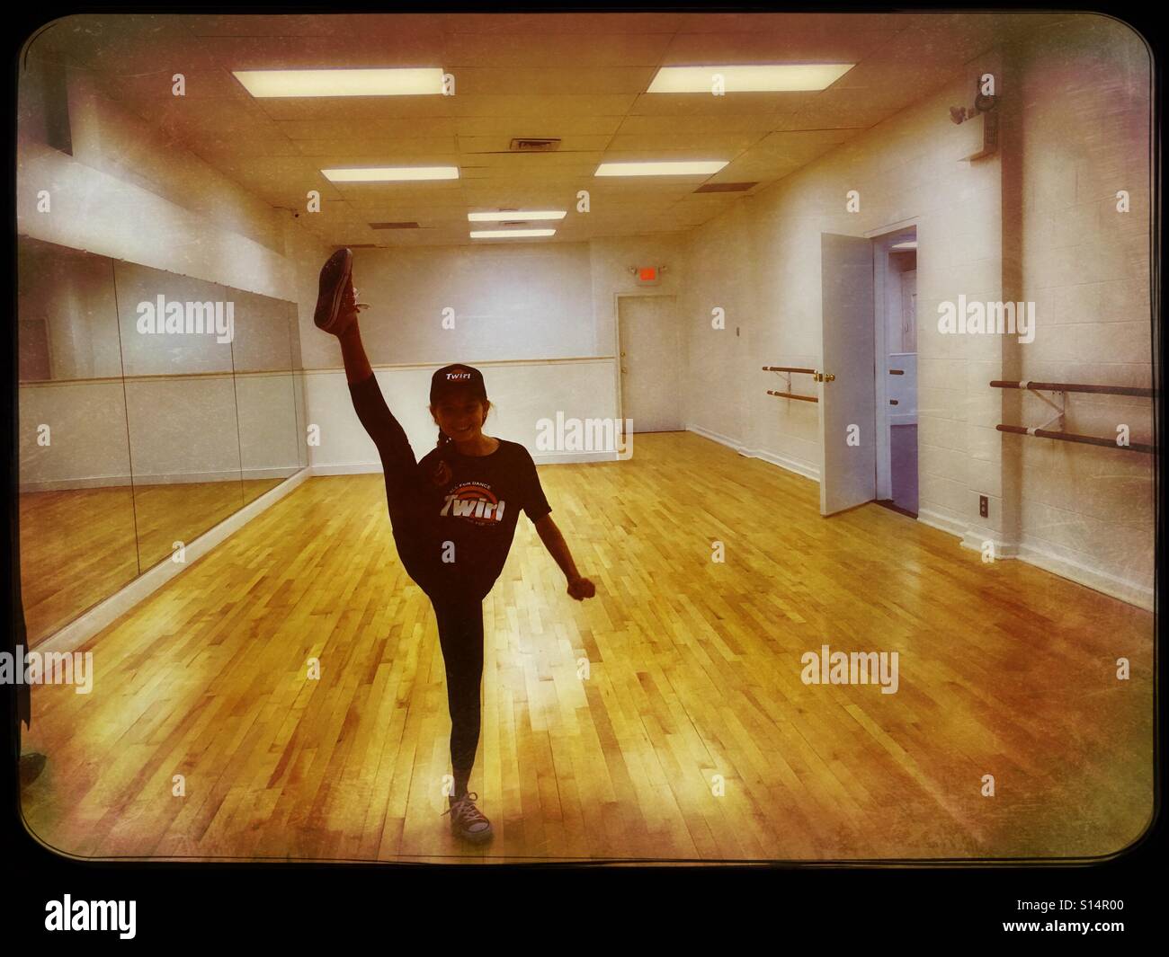 Girl doing kick in dance studio Stock Photo - Alamy