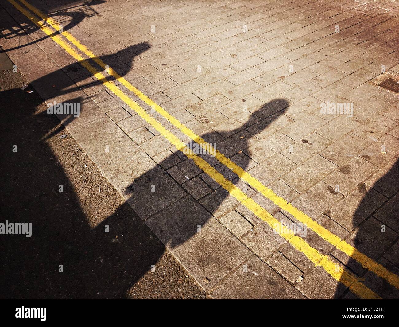 Shadows on yellow lines Stock Photo - Alamy