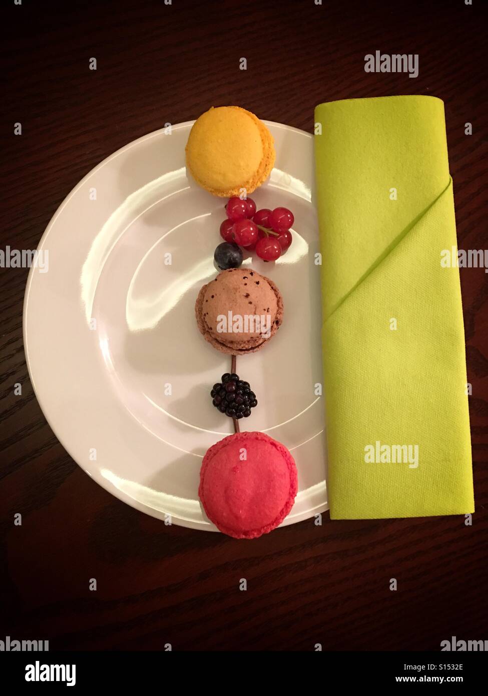 Three macaroons on a plate Stock Photo - Alamy